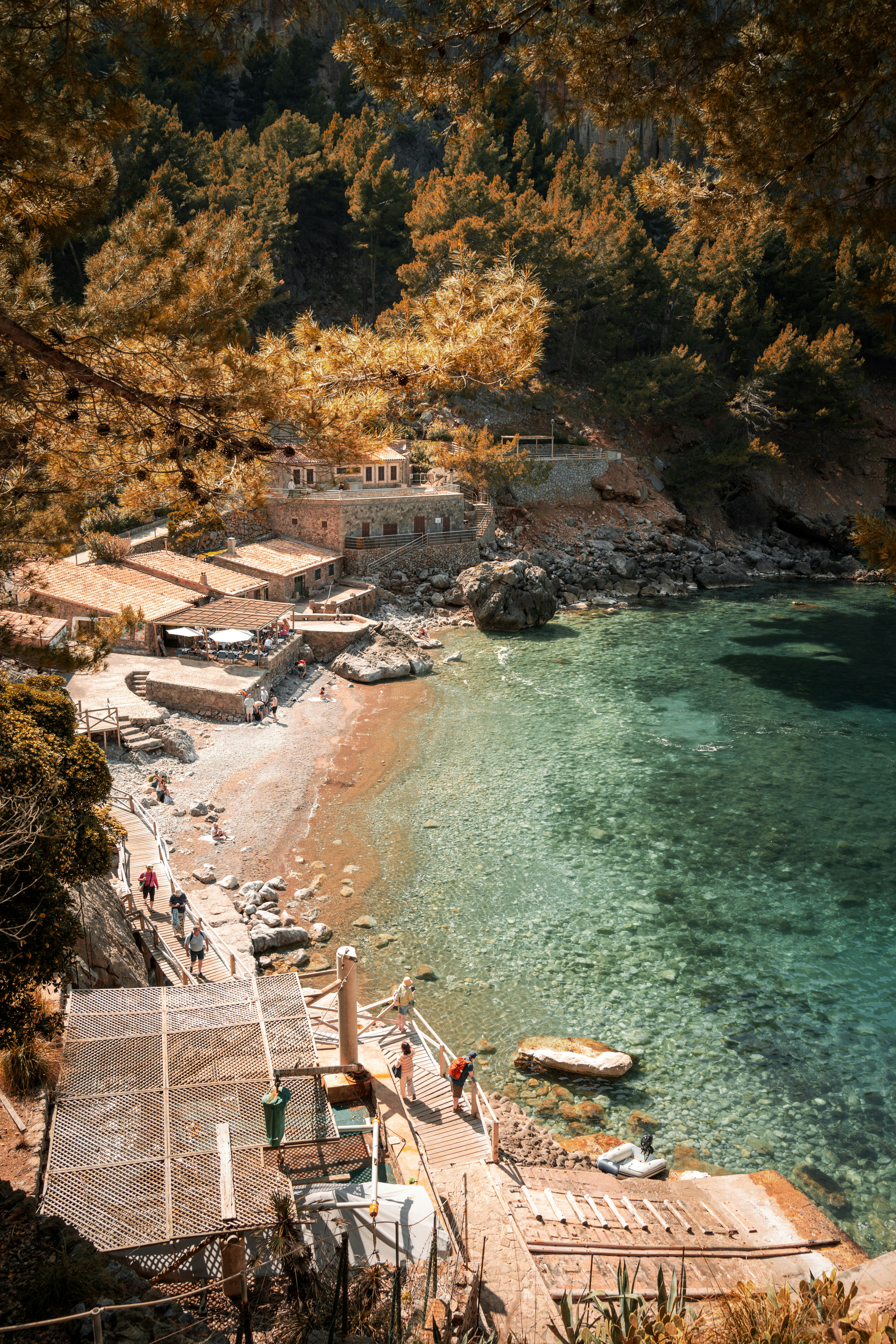 Sunlit Cove: A Rustic Path Down to Turquoise Waters