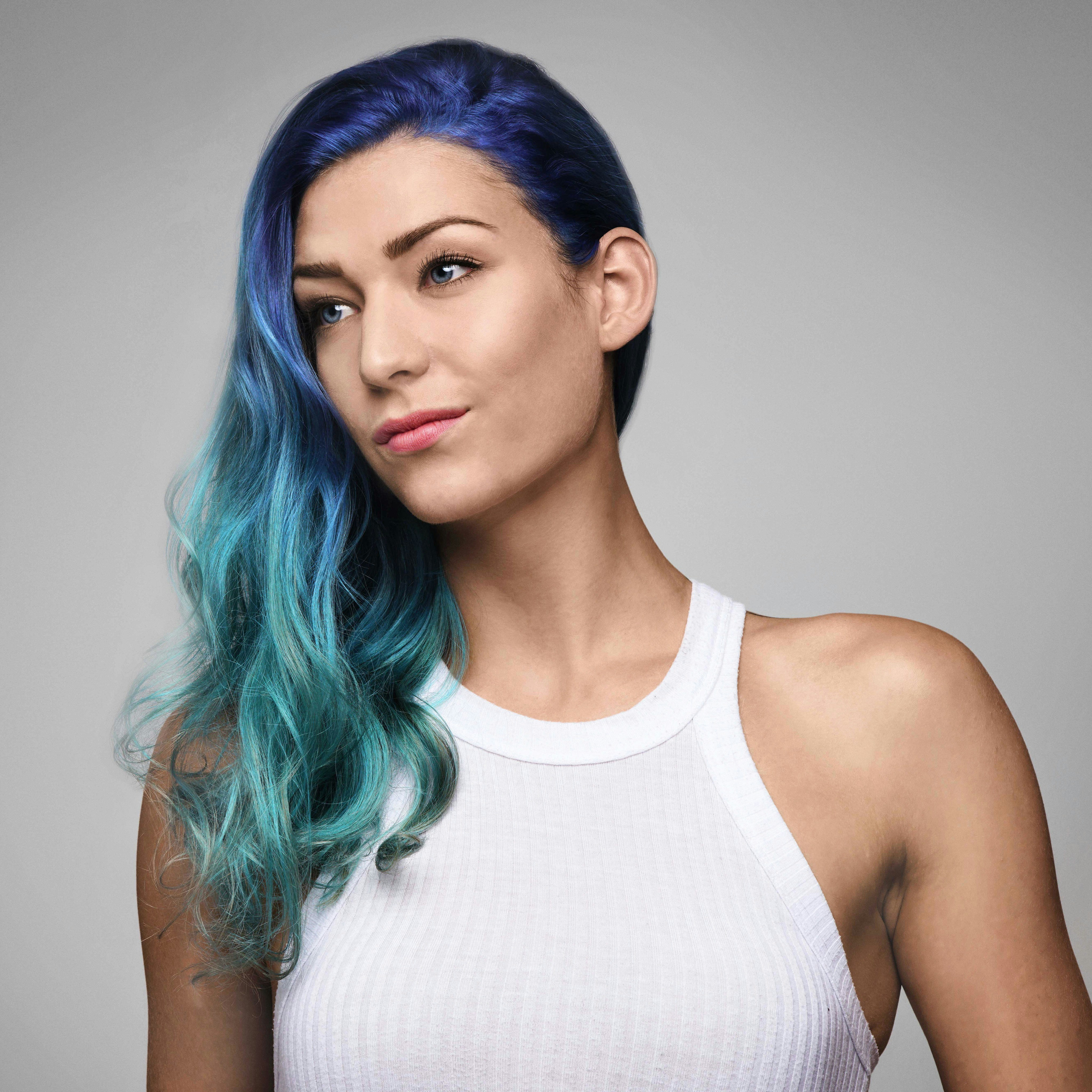 Azure fringe, emerald gaze: a portrait of contrast and confidence