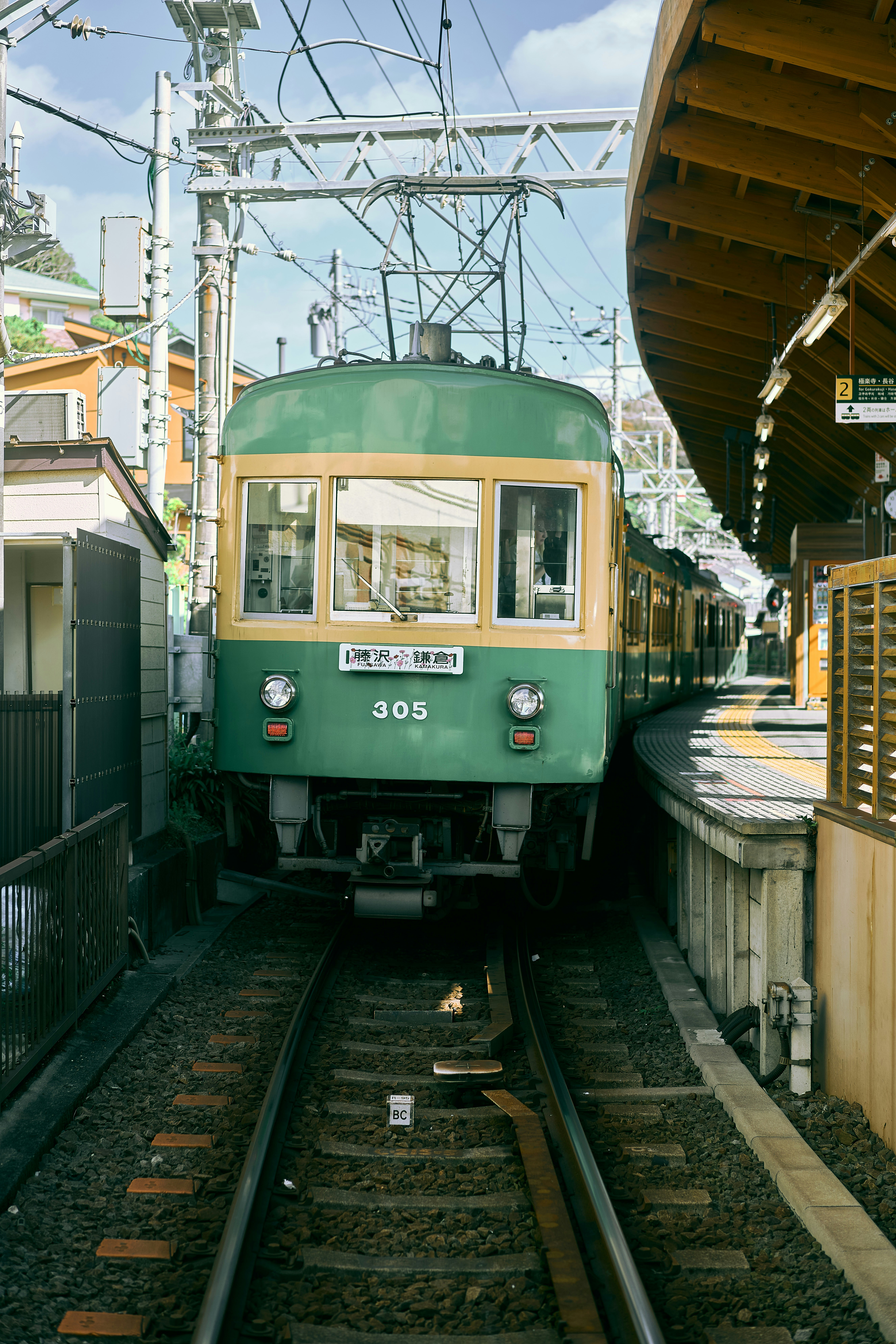 Green Electric Locomotive Emerging from the Platform