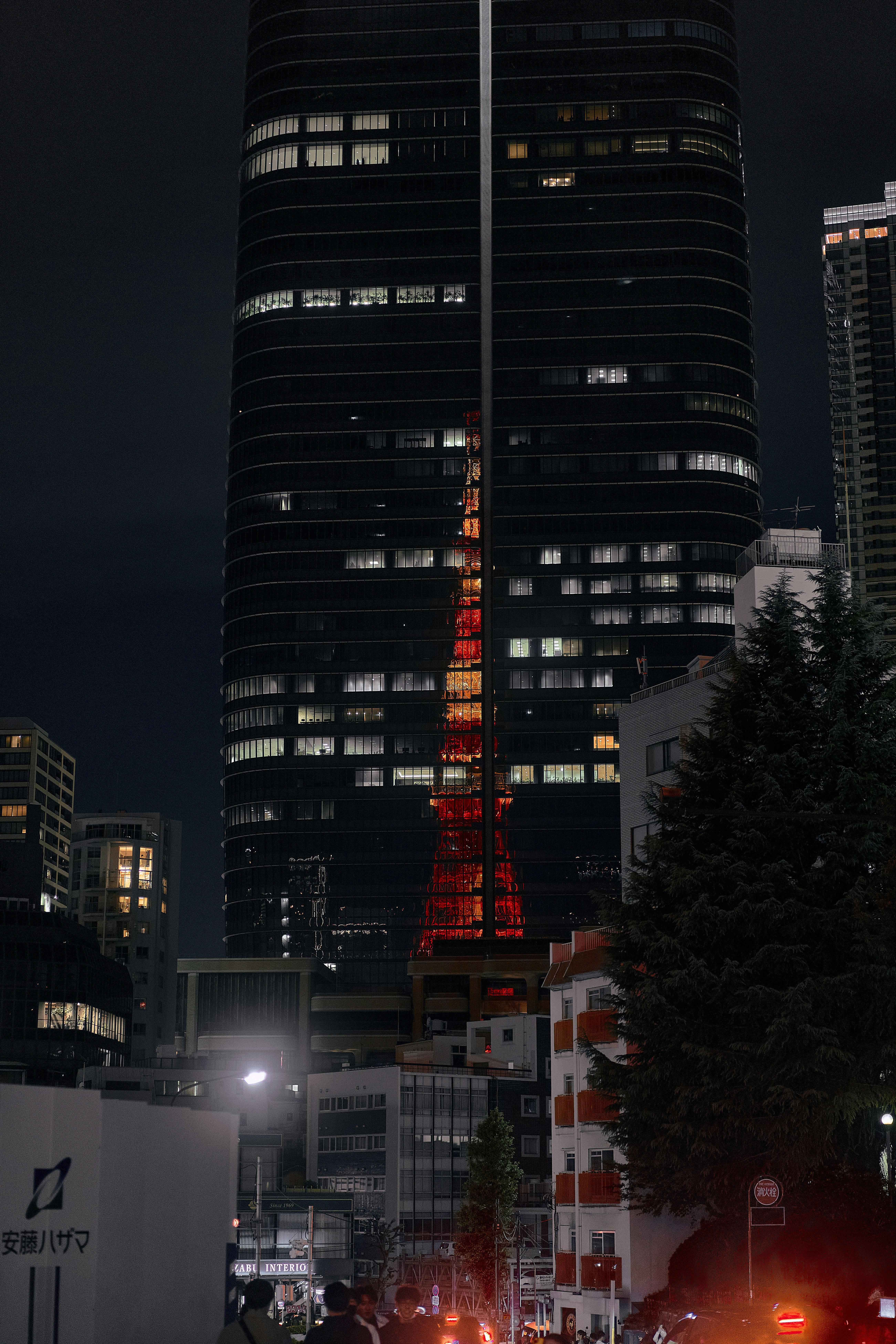 Red Hour: A Neon Needle Pierces the Night Sky