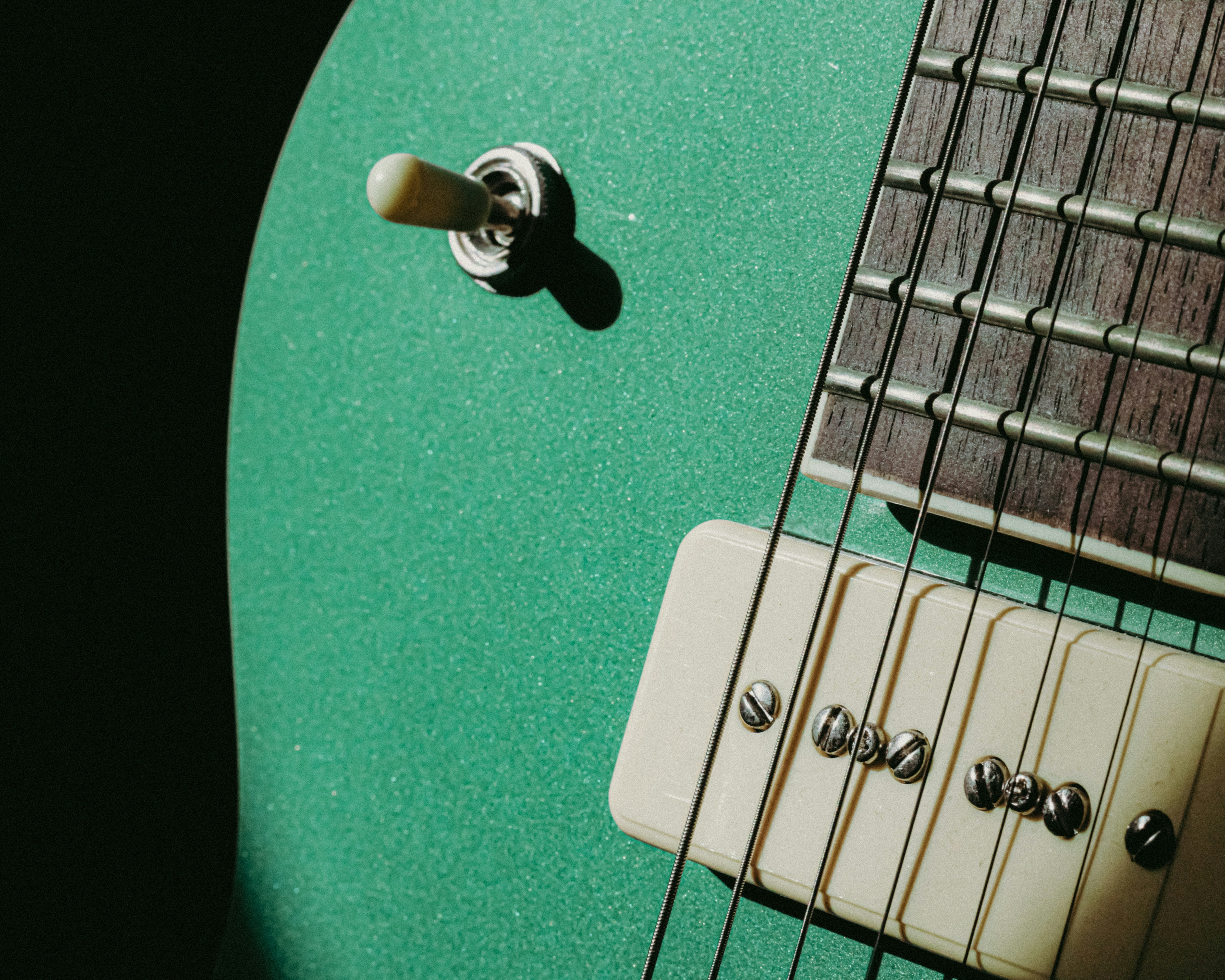 Emerald Telecaster Strings: A Close-Up of Color and Chrome