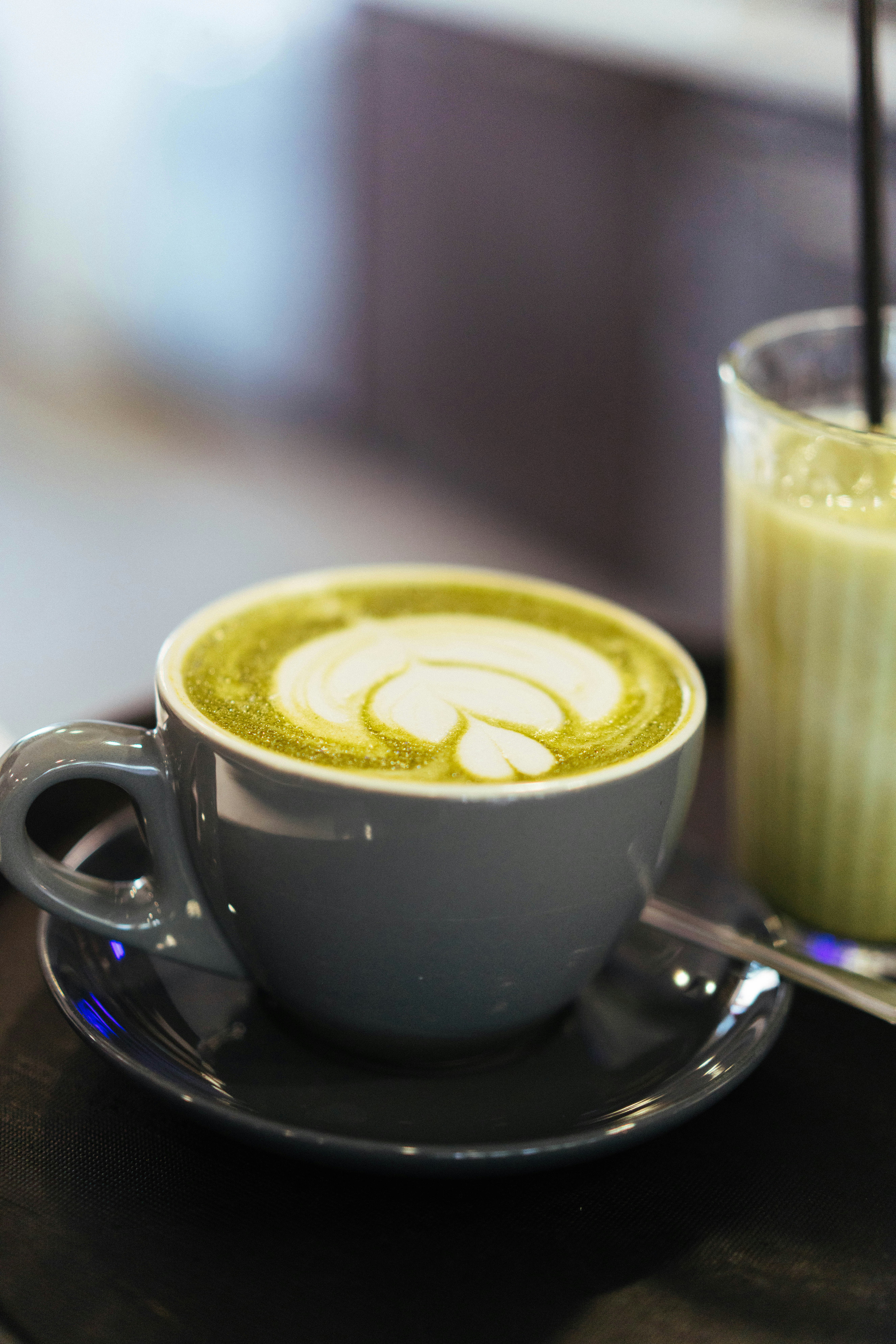 Steamed Green Harmony: A Latte Portrait by the Bar