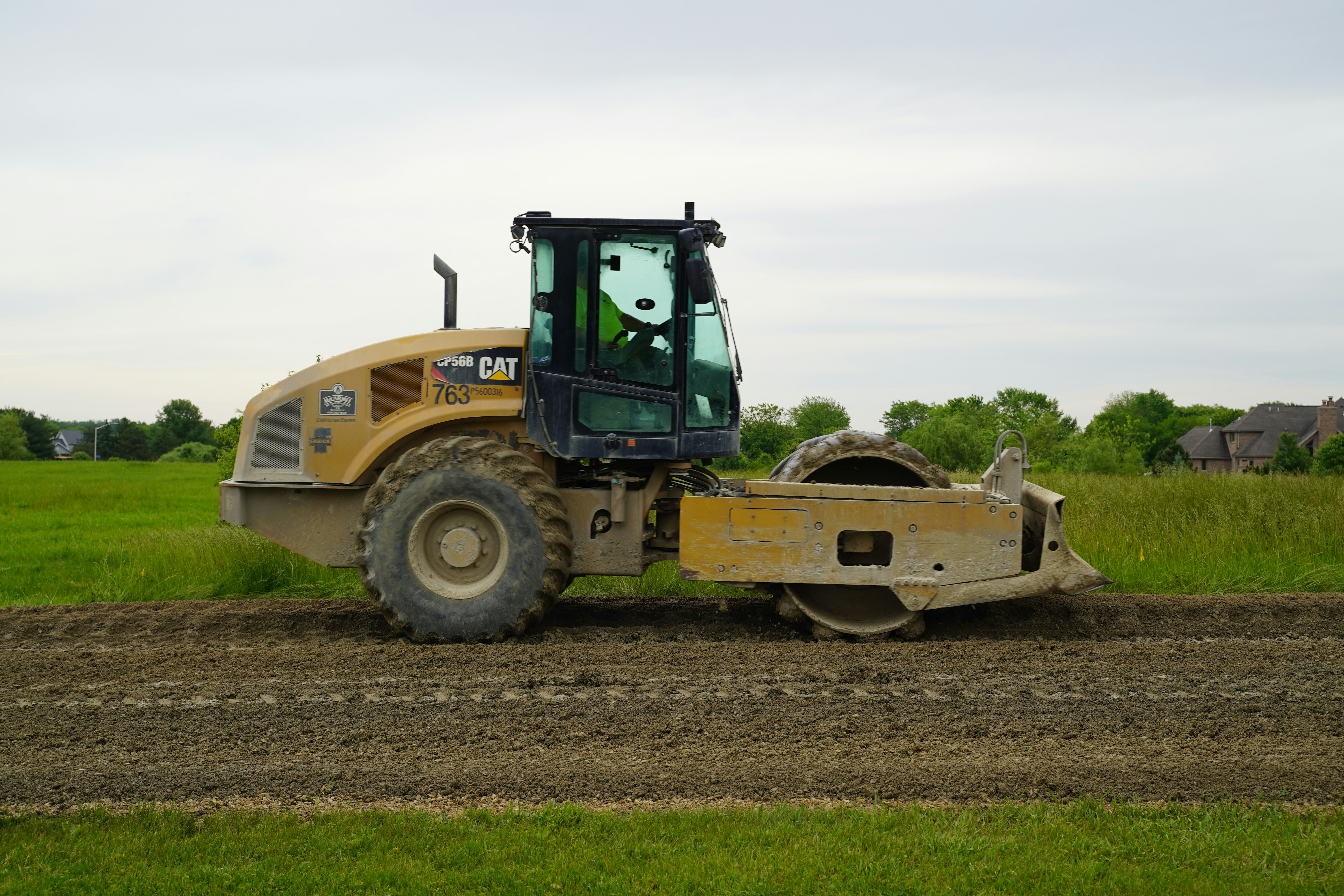 Dusty Giant at Work: The Cat Road Compactor in Glory
