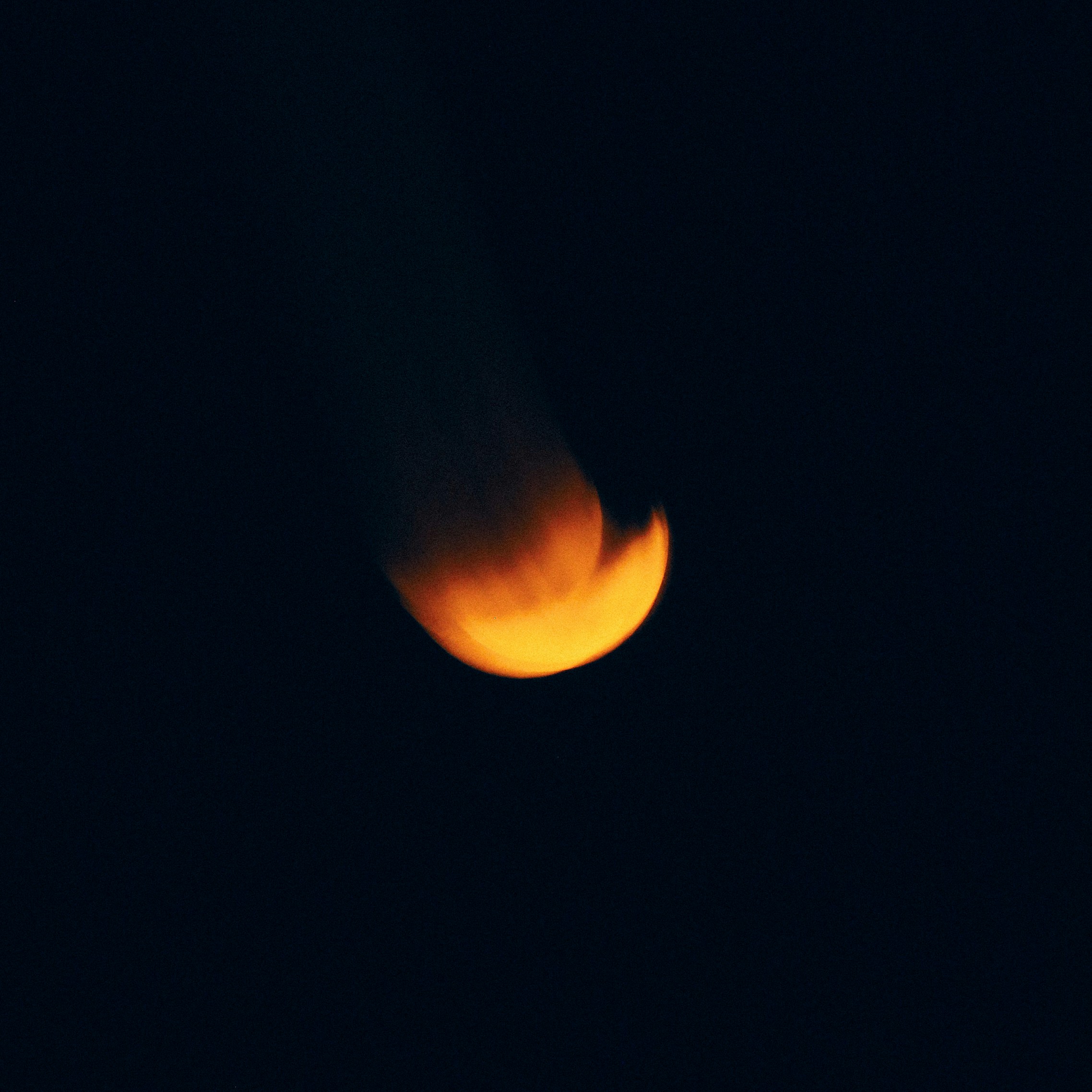 Crescent in Ember: A Lunar Sliver in Night’s Veil
