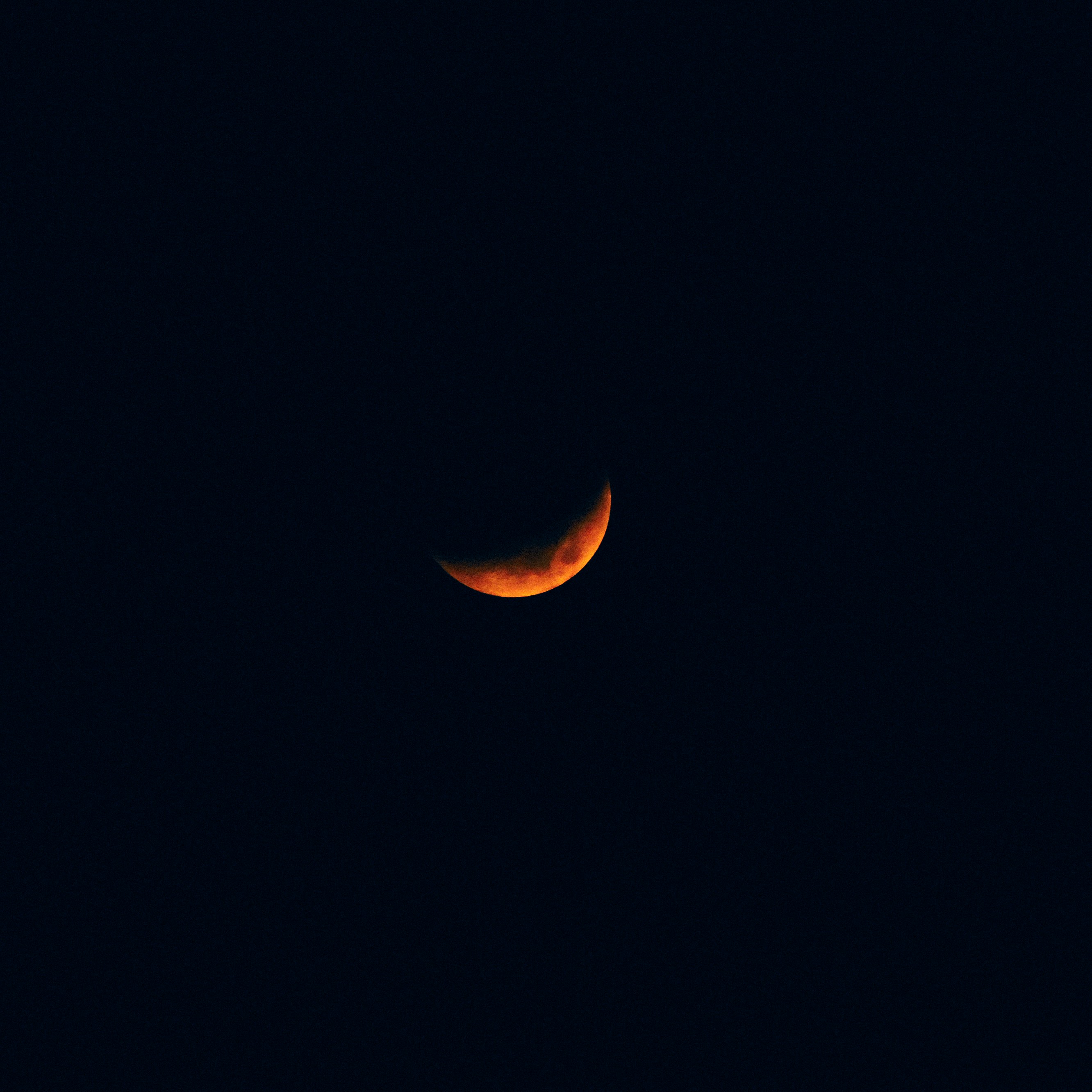 Crescent Ember: A Sliver of Sunset in the Night Sky