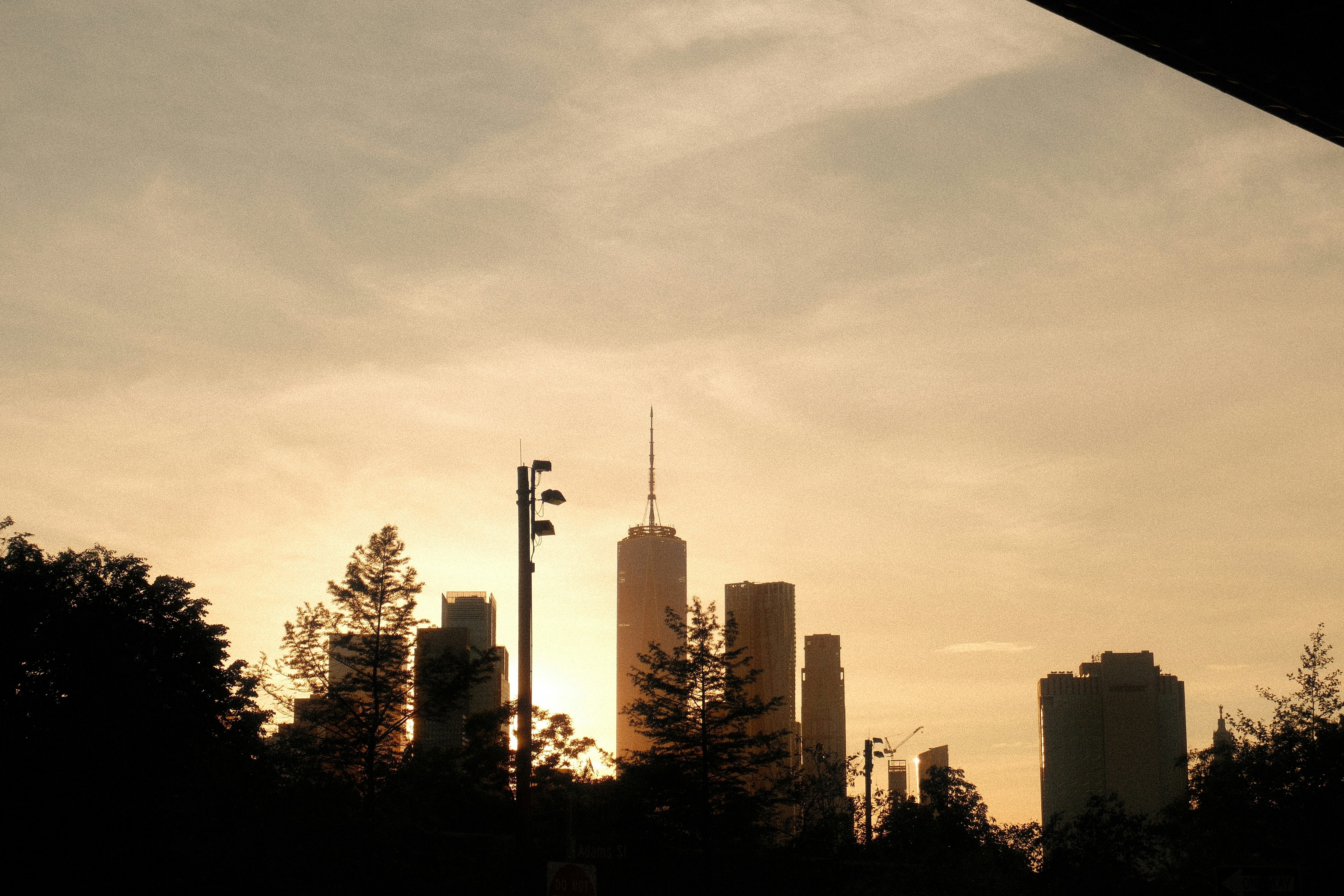 Sunset Skyline: Silhouettes Beneath the Rising City