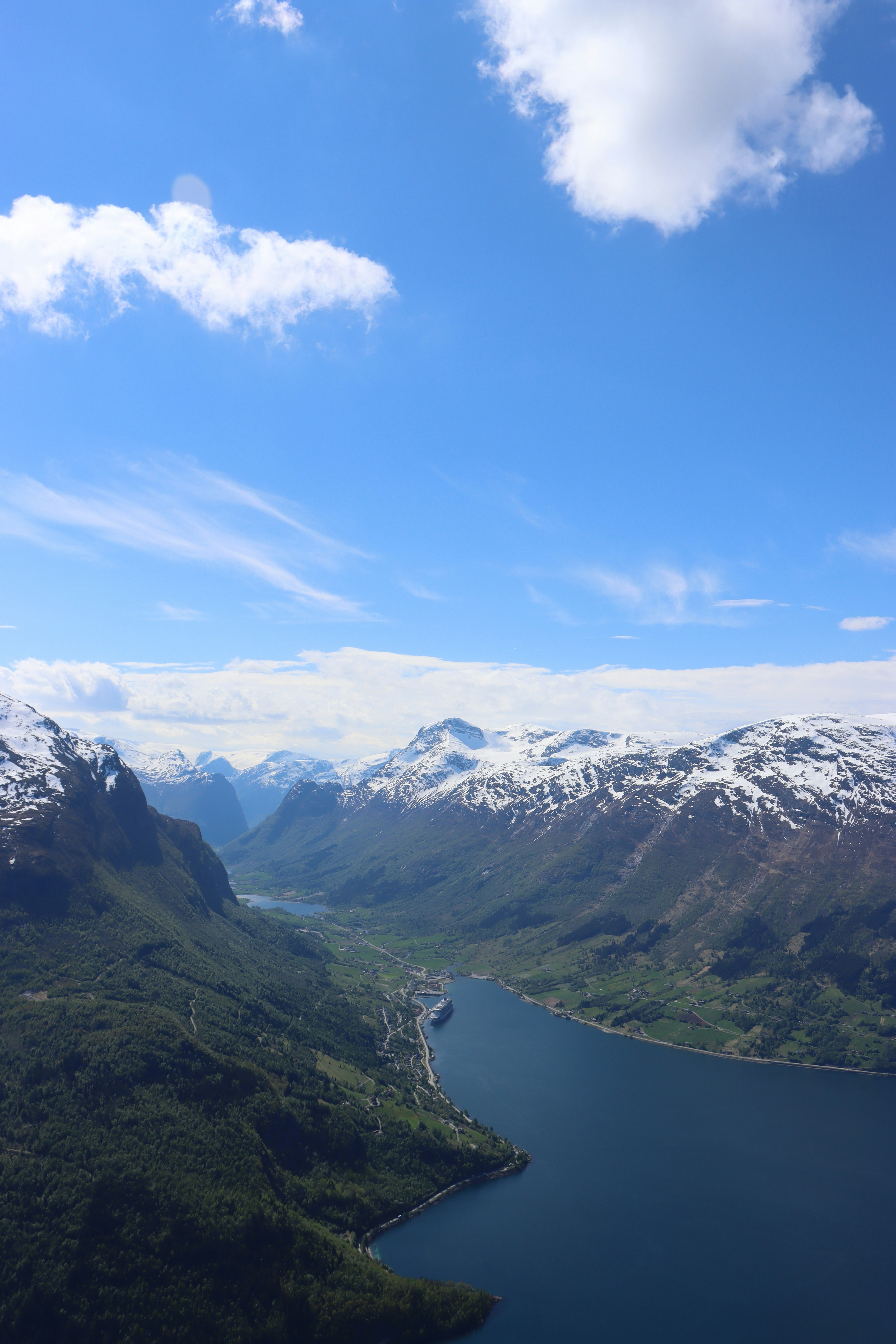Snow-kissed Peaks Over a Glacial Fjord