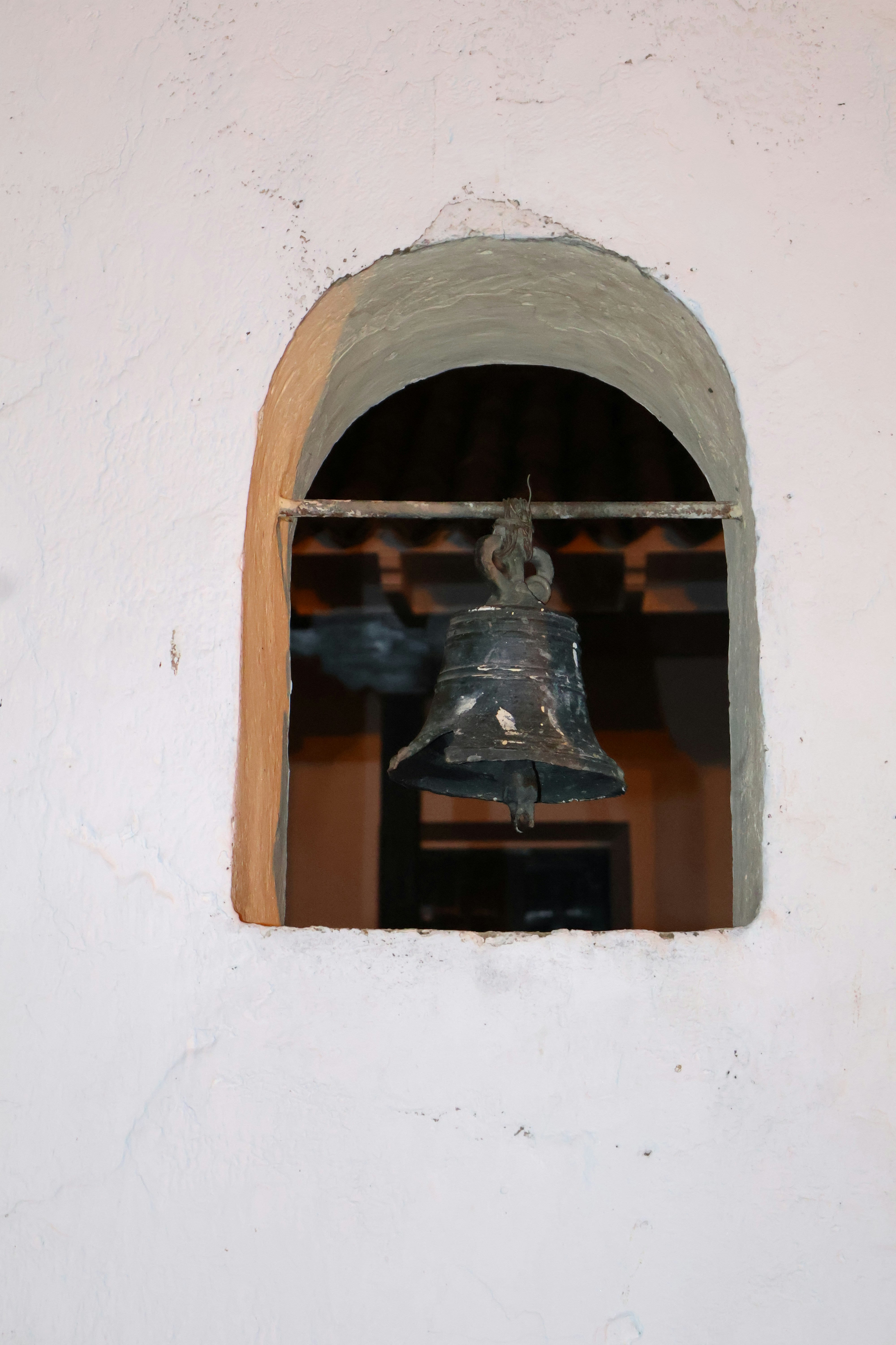 Old Bell in a White Archway: Quiet Repetition of Time
