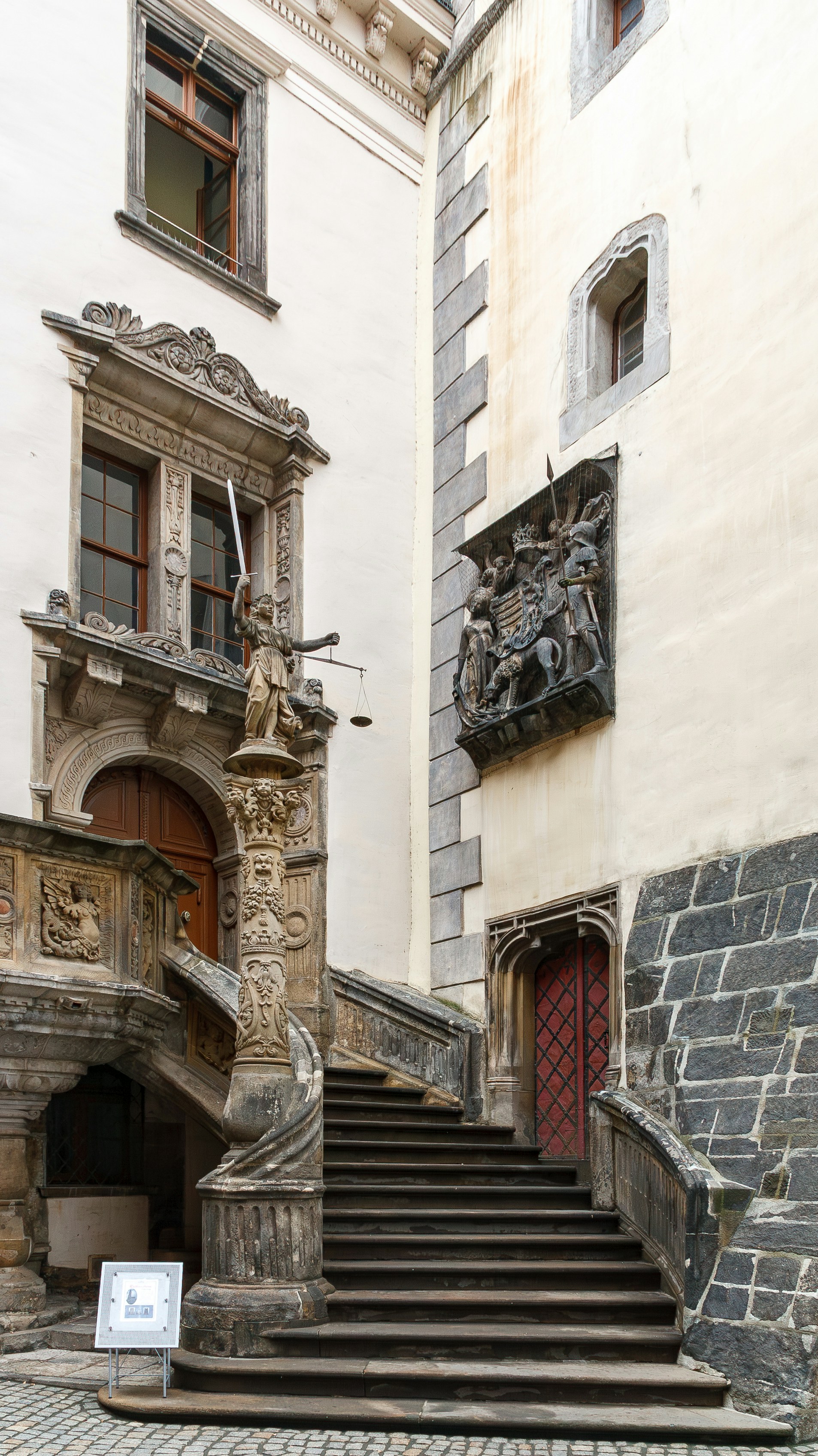 Stone Spiral: A Historic Staircase Framed by Monumental Facades