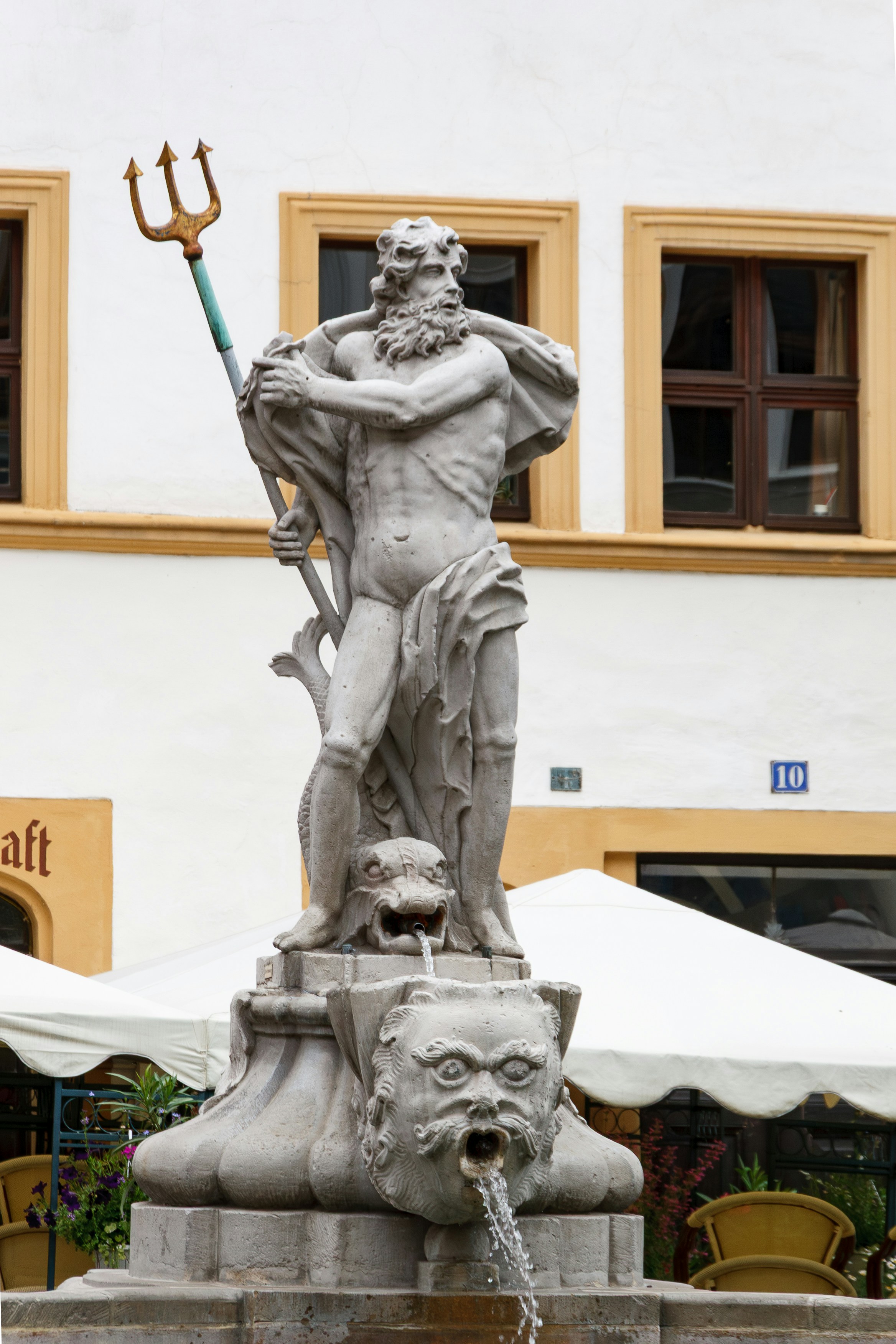 Statue of Poseidon Guarding the Fountain in a European Square
