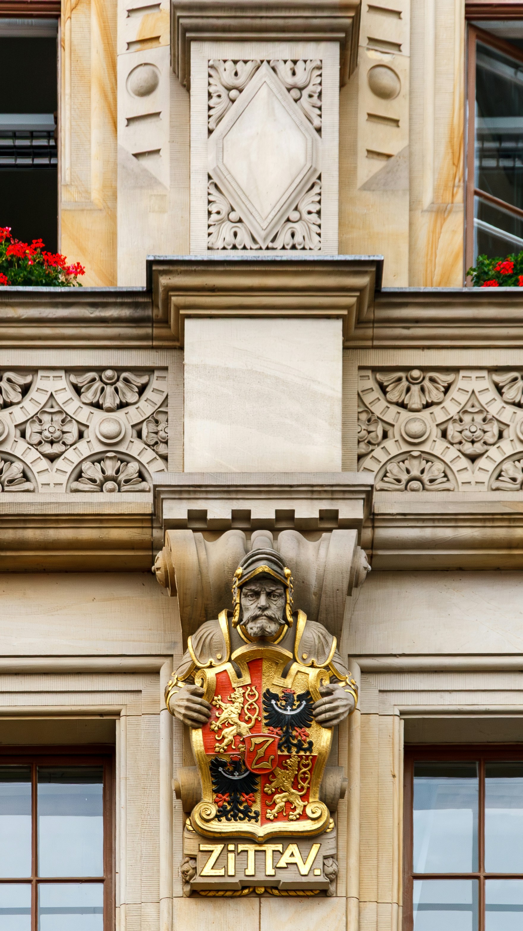 Heraldic Guardian: A Carved Crest Beneath Ornate Architecture