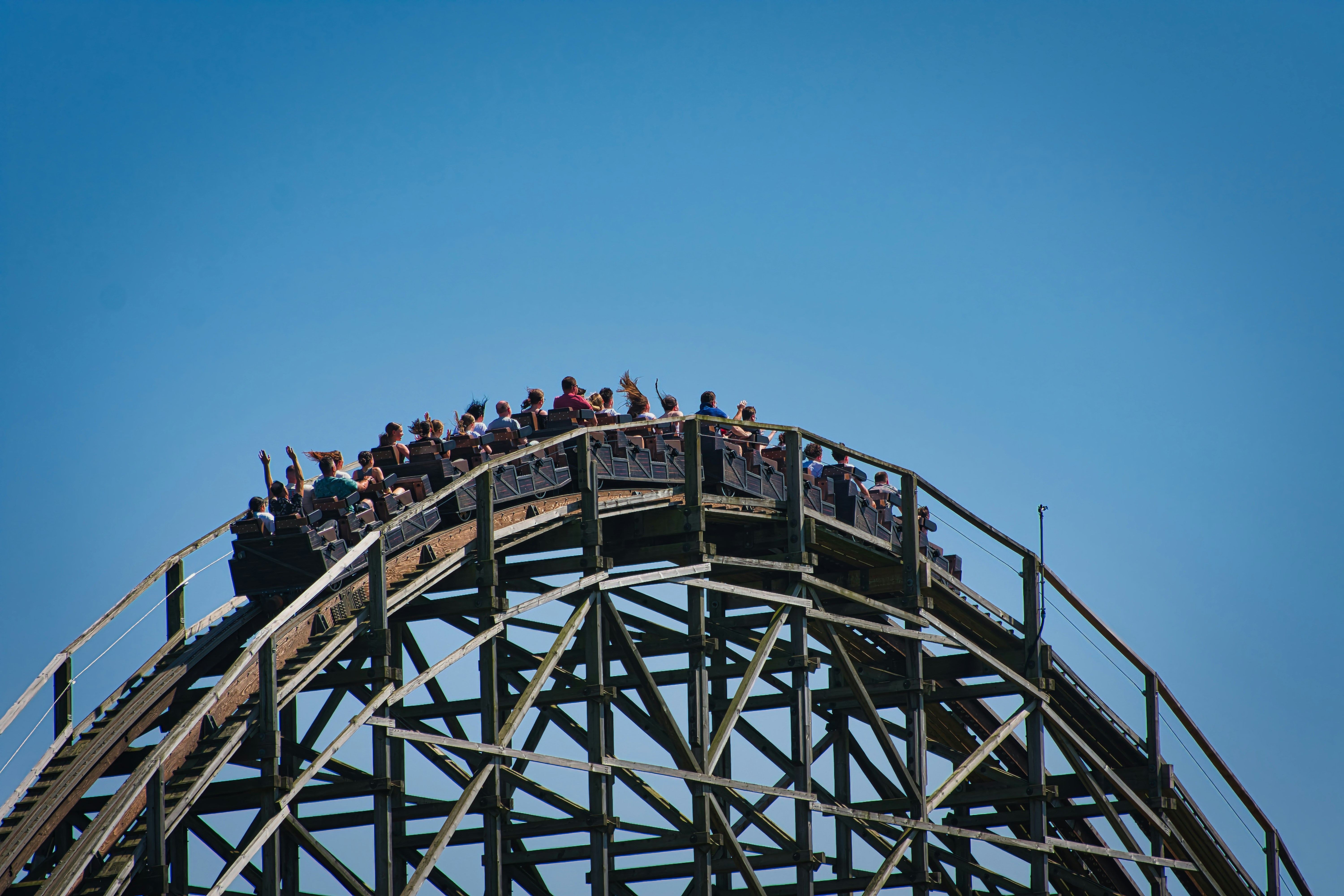 Crowd Cheering at the Peak of a Wooden Roller Coaster