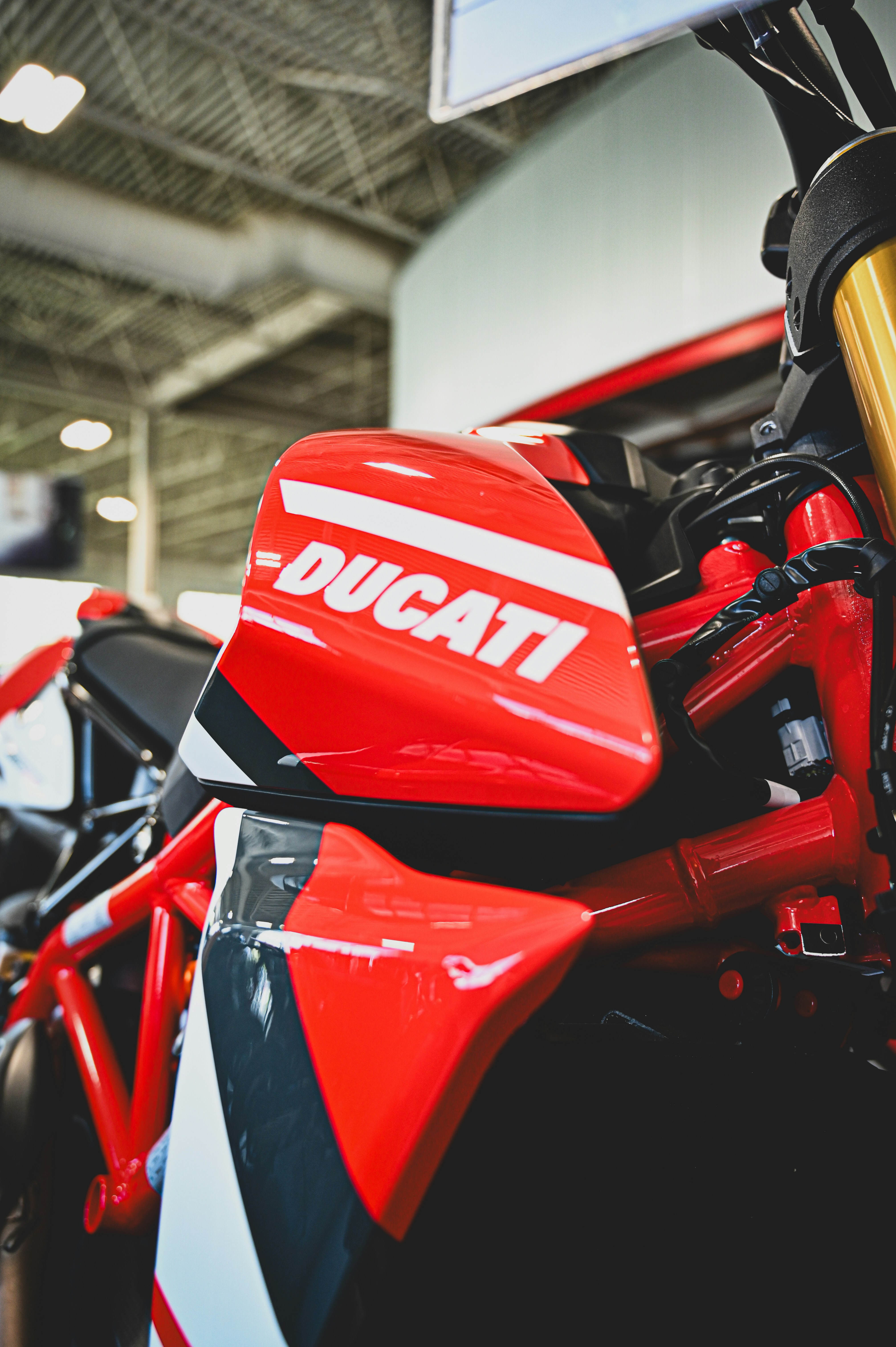 Chrome-red Ducati Edge: Close-up of the Richly Polished Tank in a Showroom