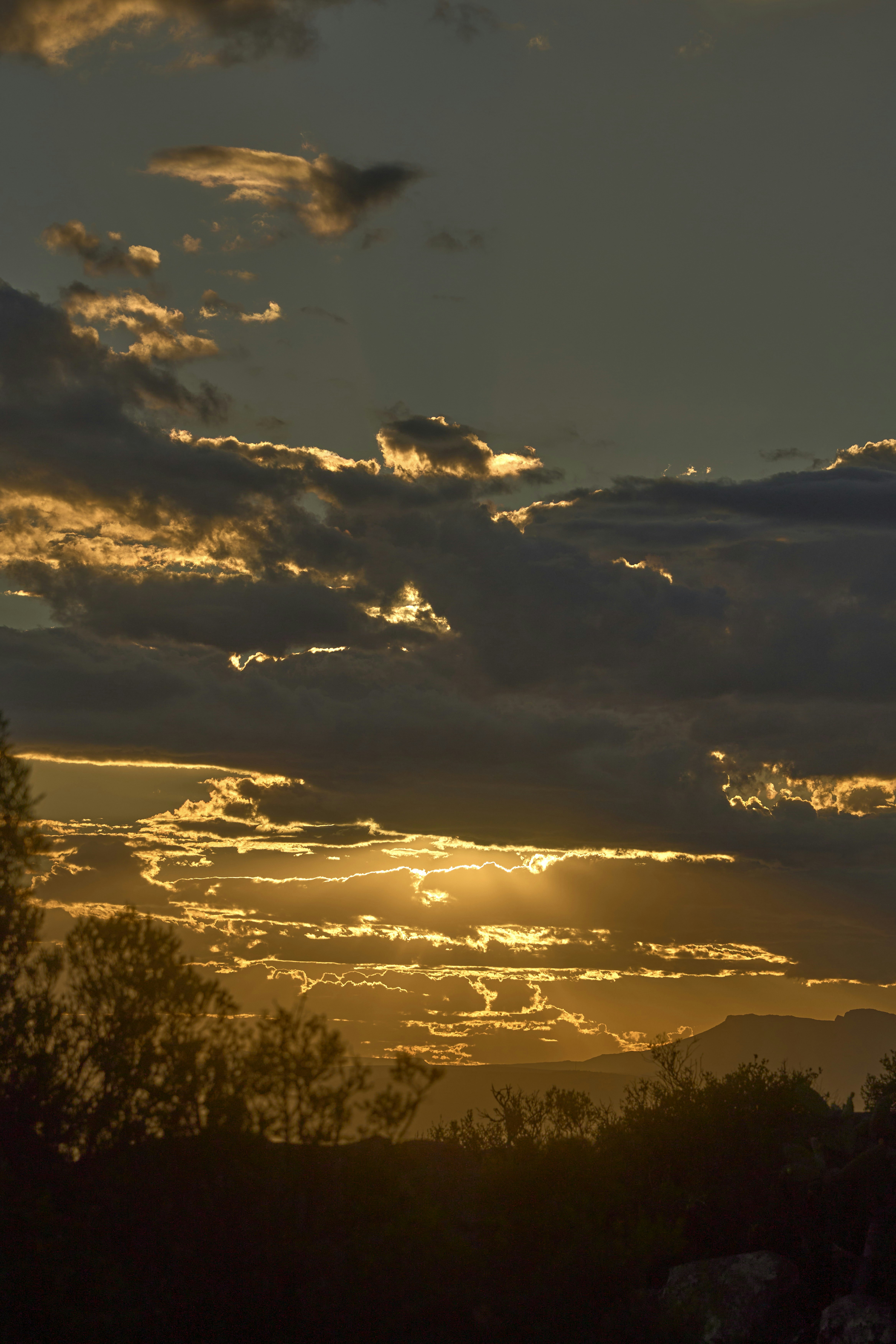 Golden Rim: Sunset Over Silhouetted Landscape