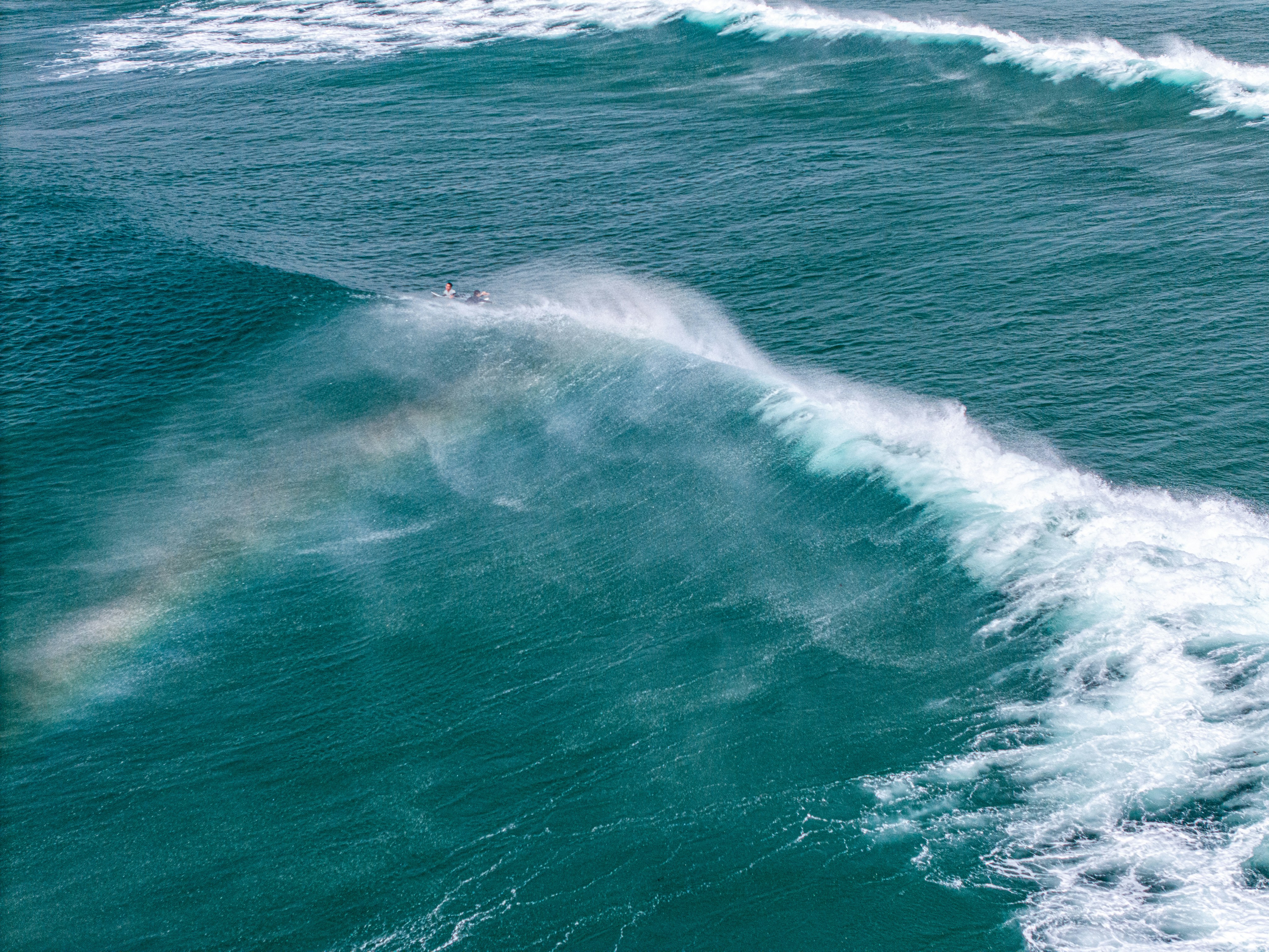 Rogue Crest: A Surfer's Dimensional Glide Through a Turquoise Break