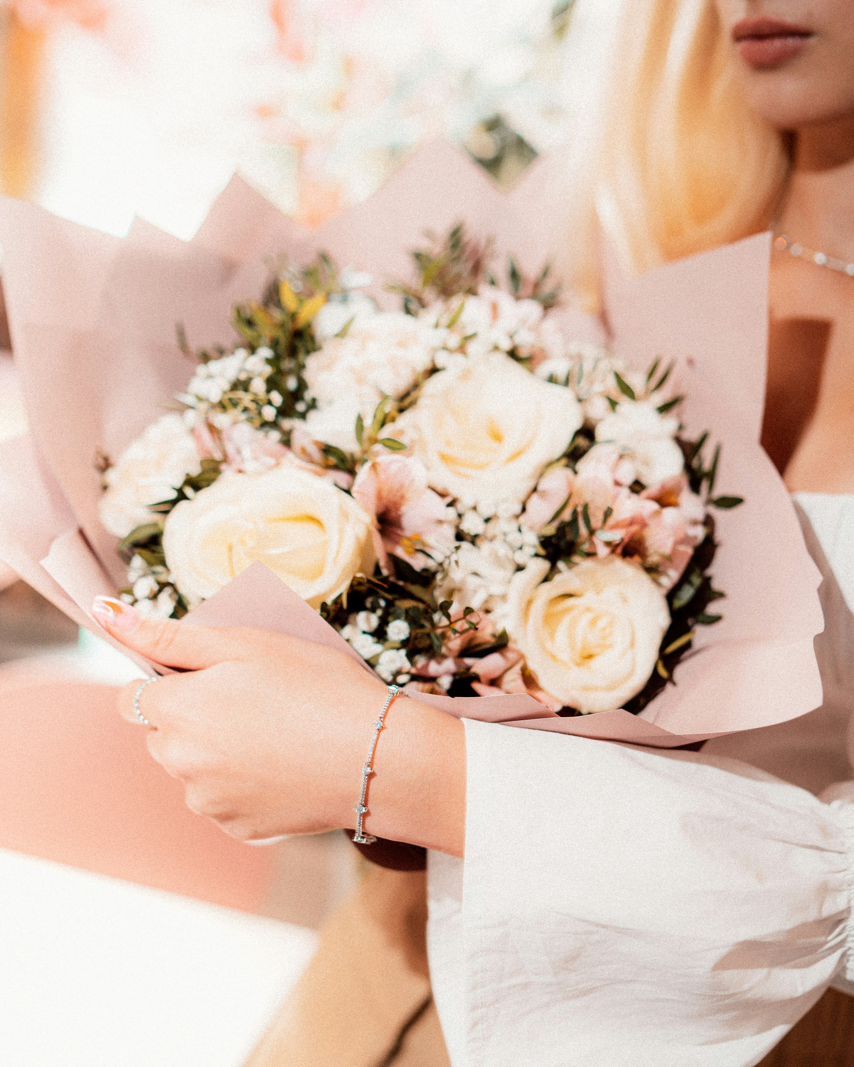 Bouquet of Cream Roses and blush accents, captured in soft bridal light