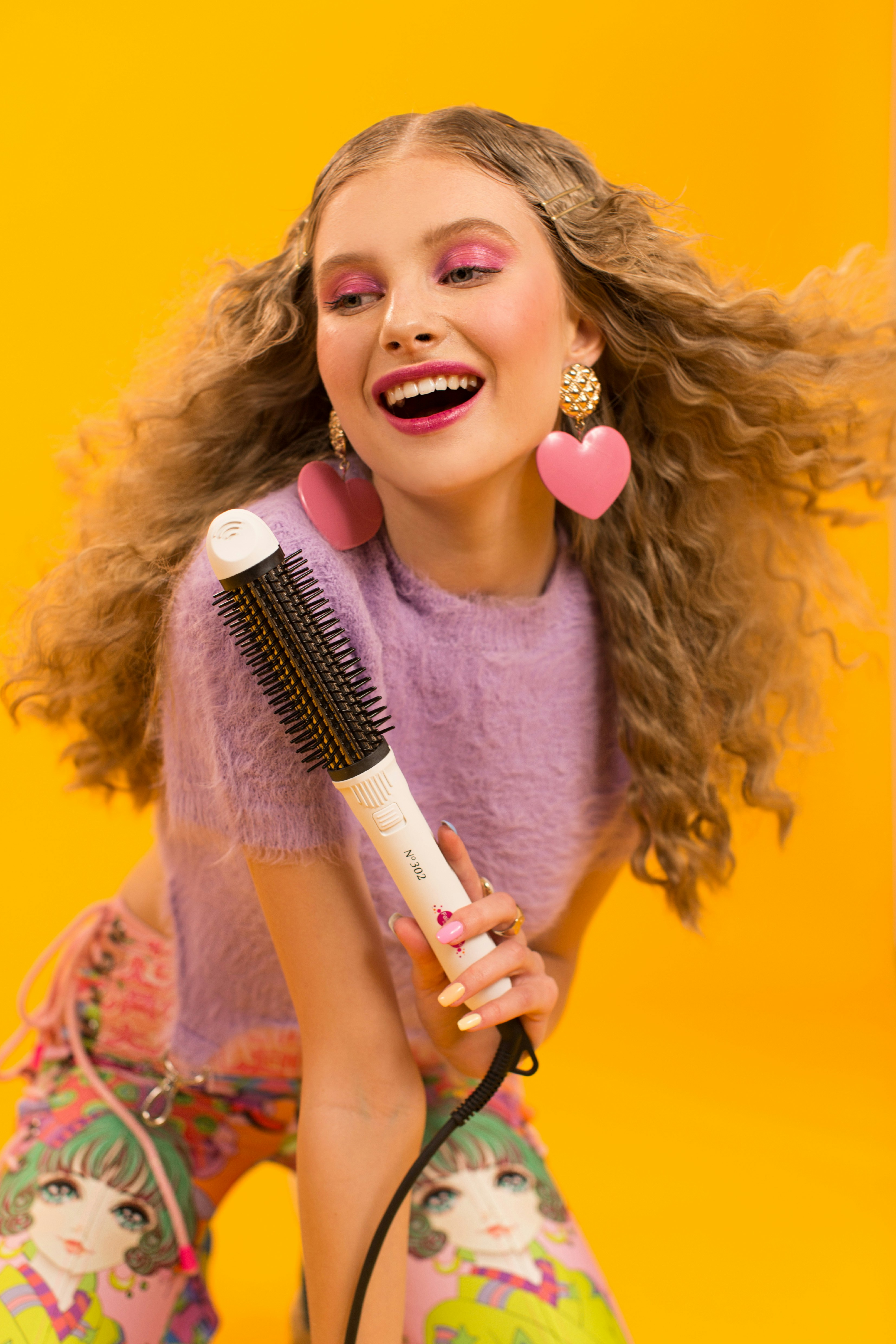 Vibrant Studio Spin: Pink Hair, Gold Accents, and a Hairbrush Hero