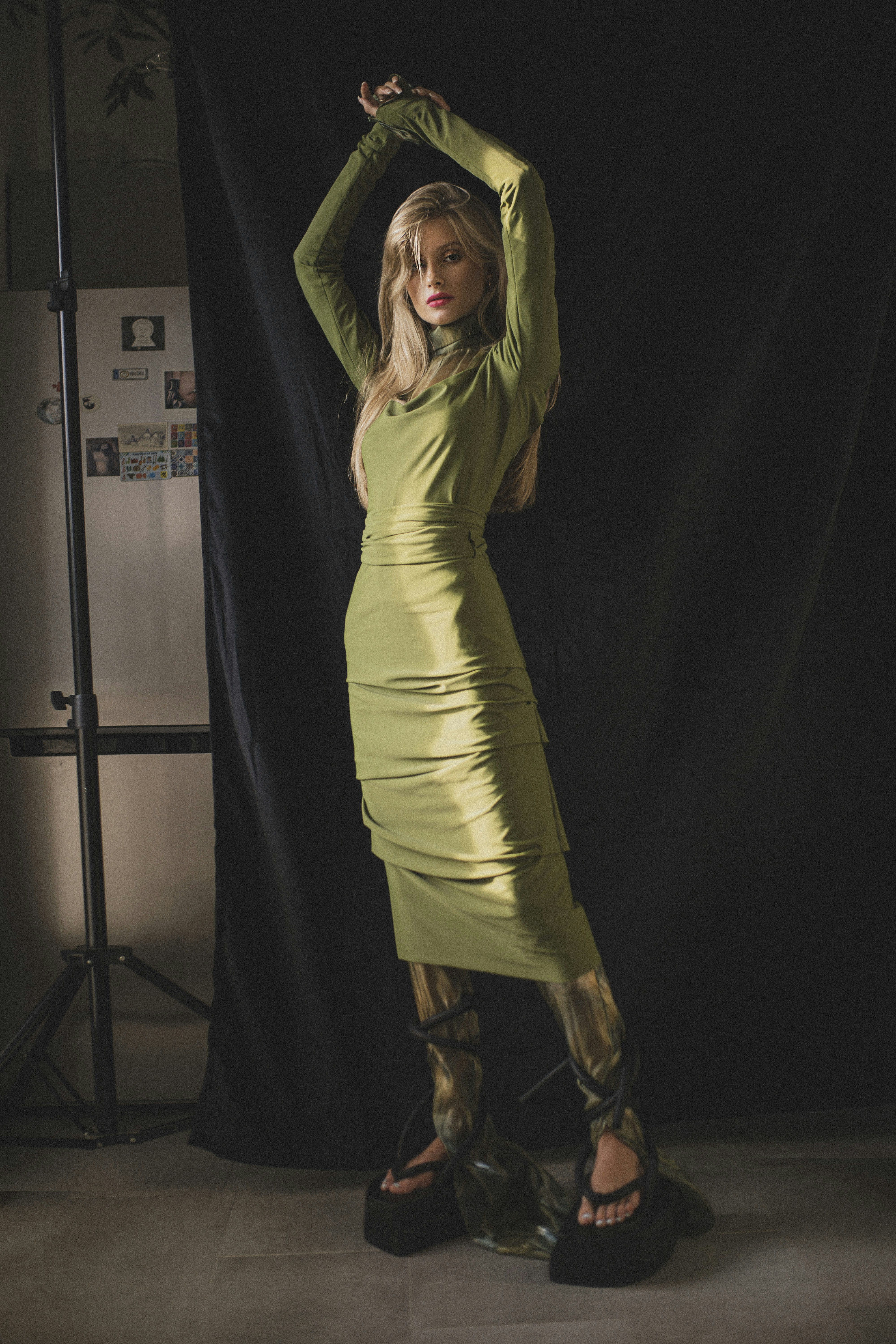 Emerald Silhouette: A Poised Pose in a Lime Dress