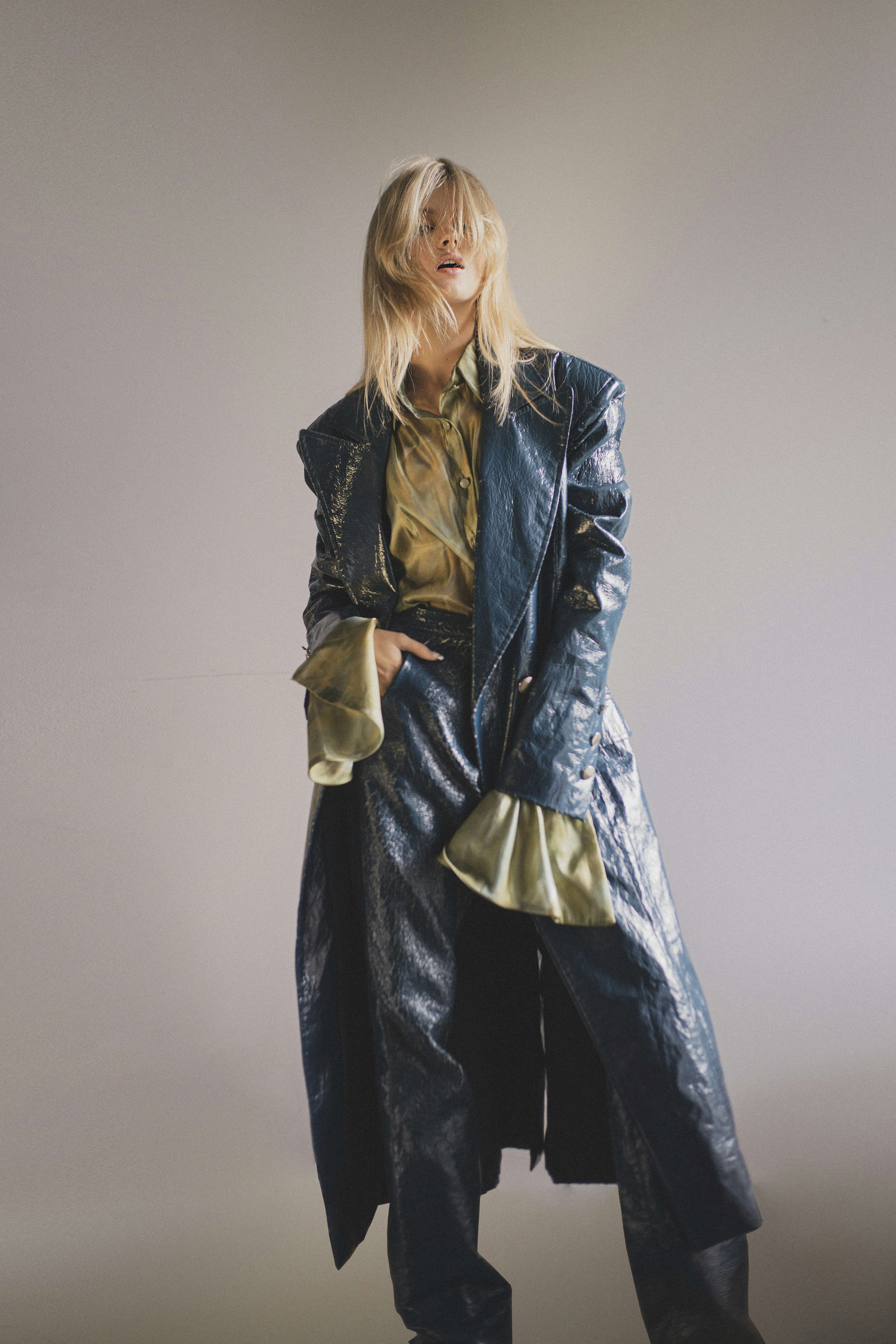 Mesmeric Edge: A Fashion Portrait in Metallic Blue Overcoat