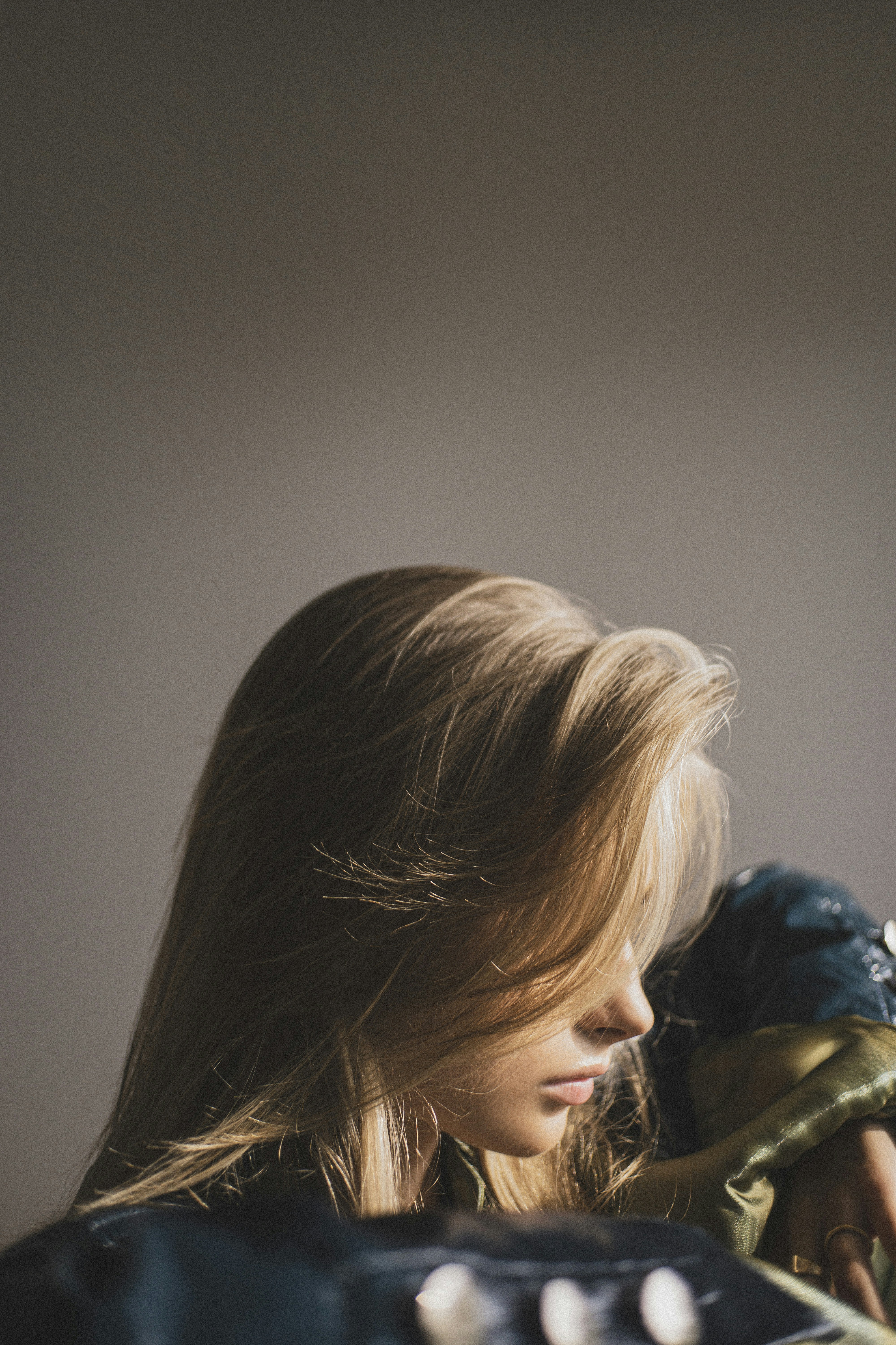 Softly Lit Portrait: A Quiet Embrace of Hair and Glove