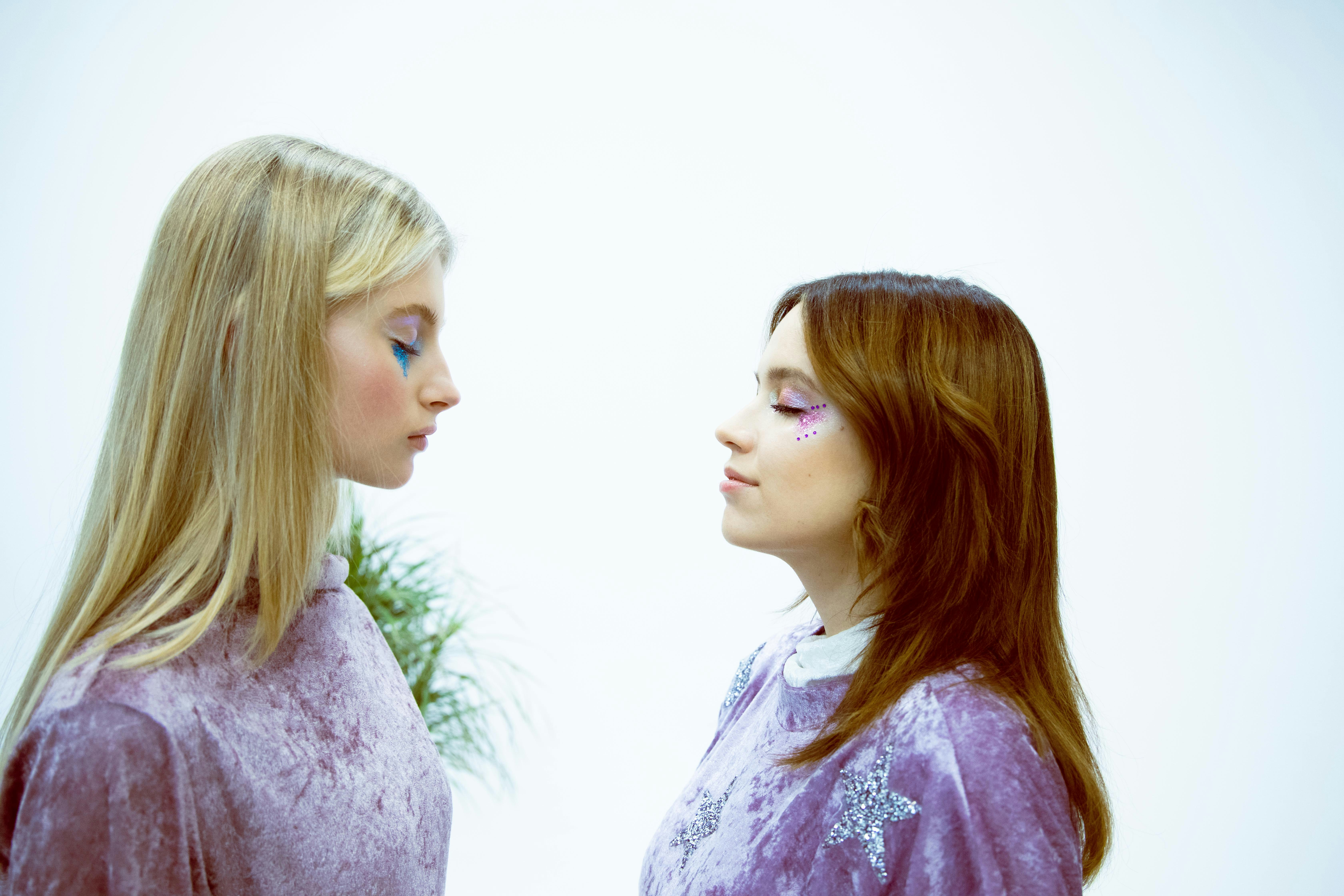 Twin-Soft Gaze: Quiet Portrait of Two Partners in Pastel Violet