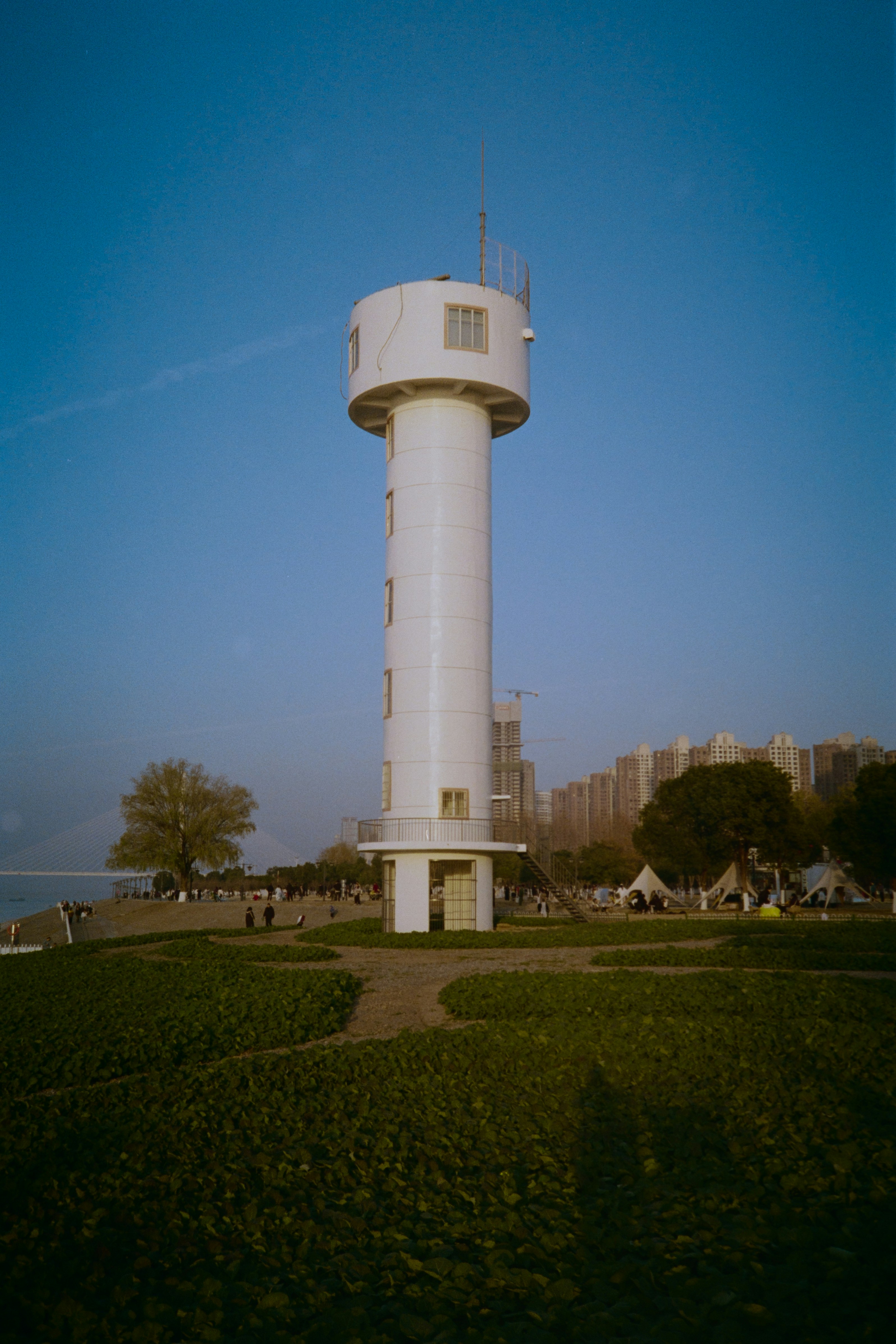 White Lighthouse Rising: A Seaside Monument Against a Clear Sky