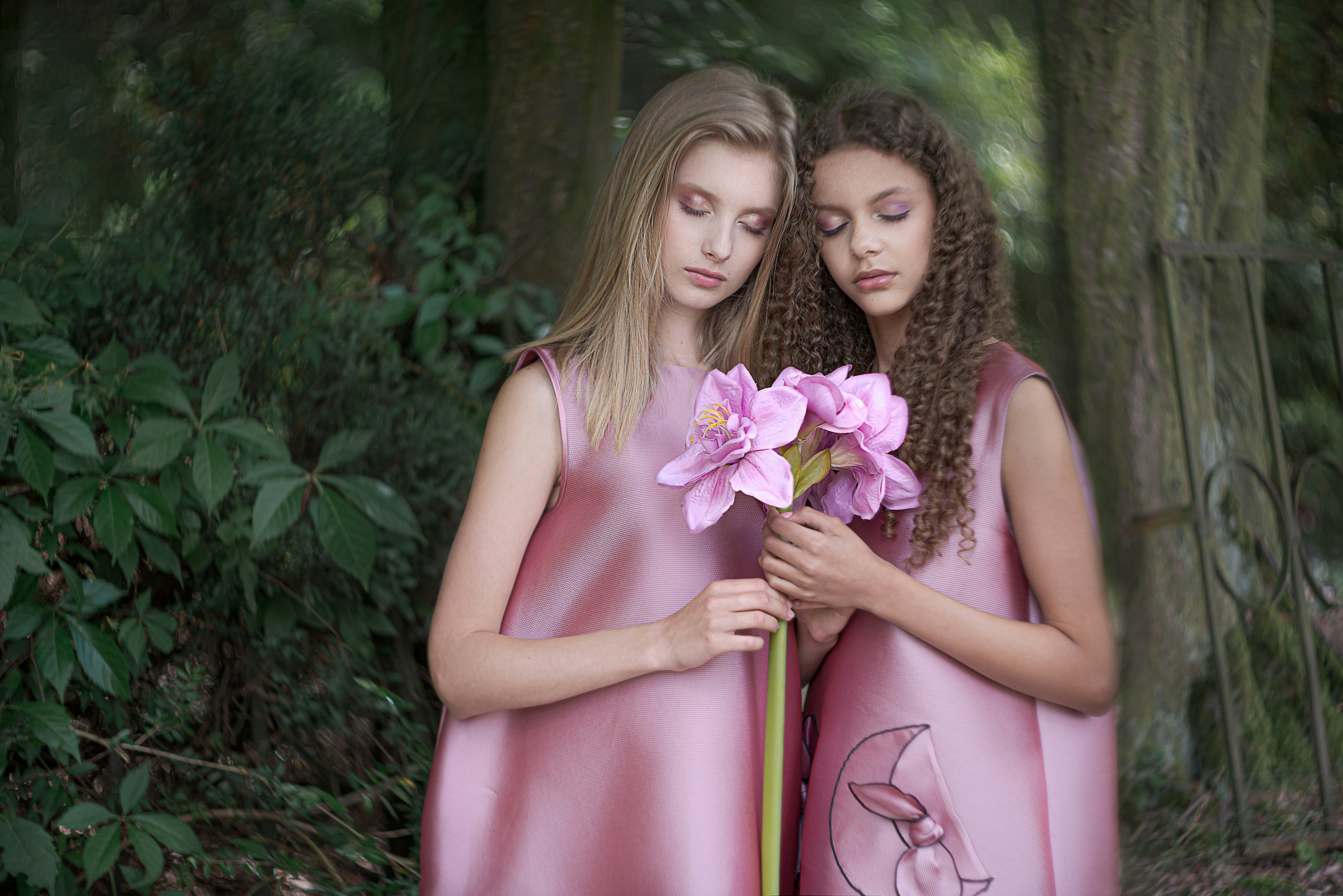 Blush Silhouettes: Twin Figures in a Quiet Garden