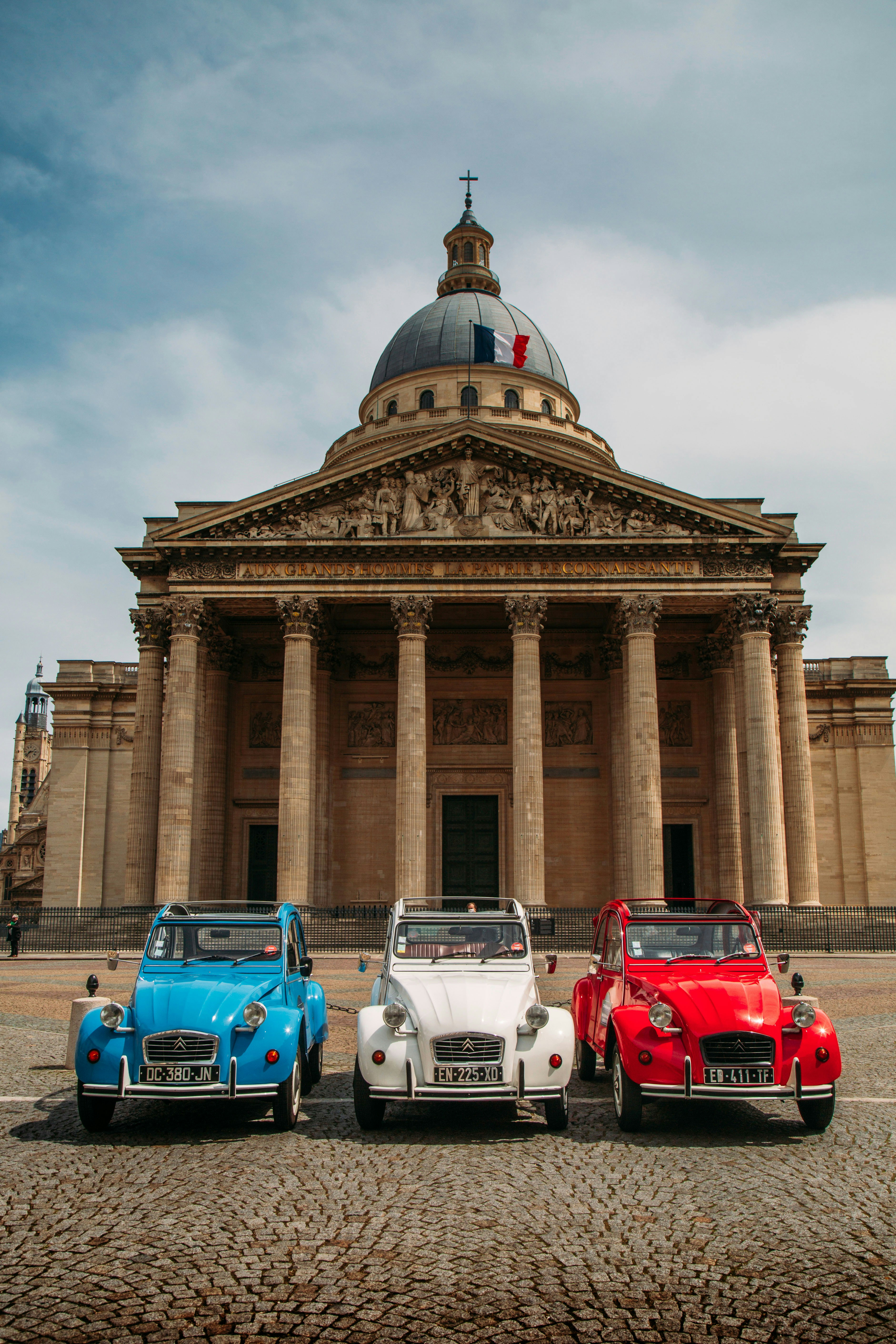 Three Classic Convertibles Parade the Steps of a Neoclassical Facade