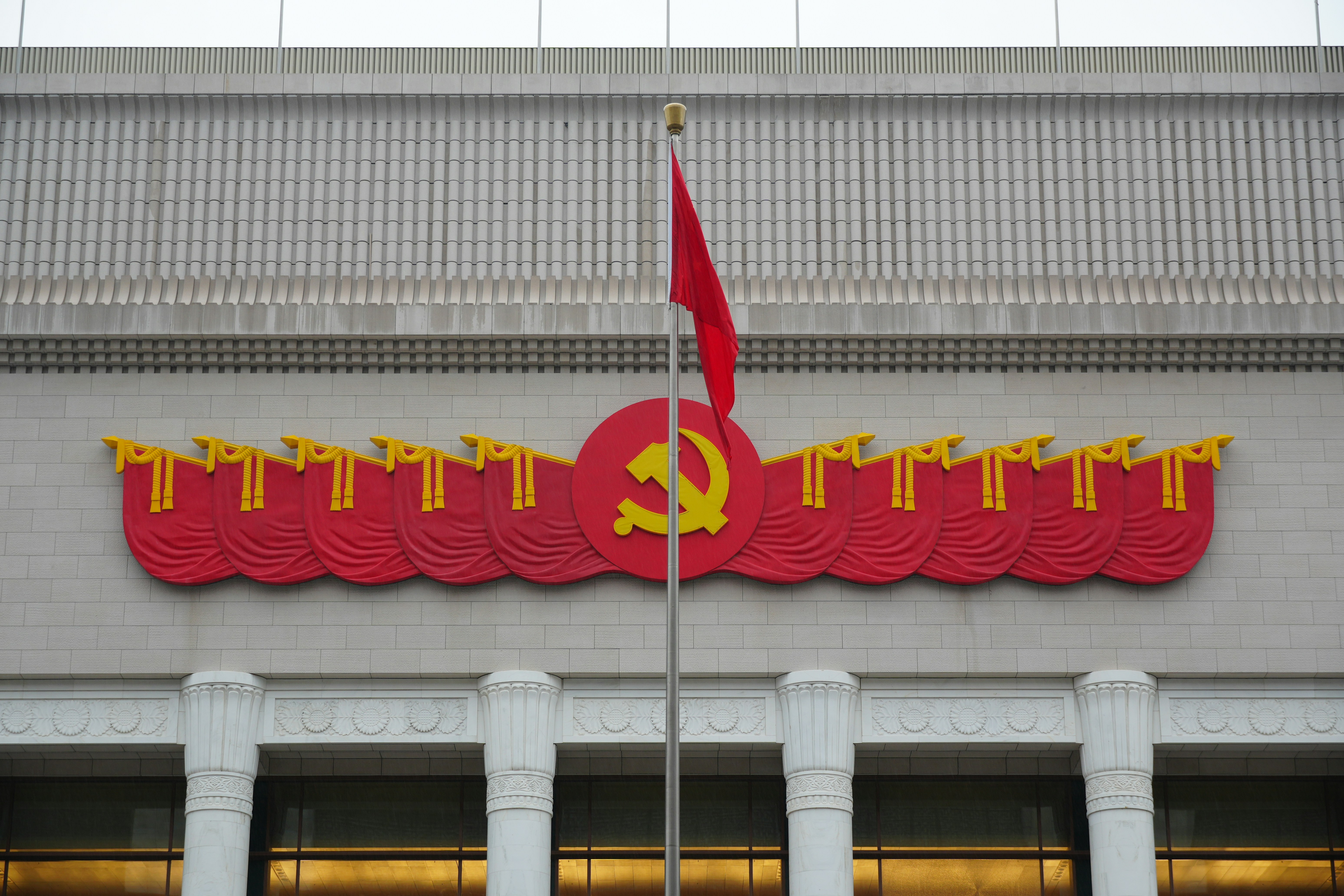 Flagpole Centered under Communist Emblem over Classical Facade