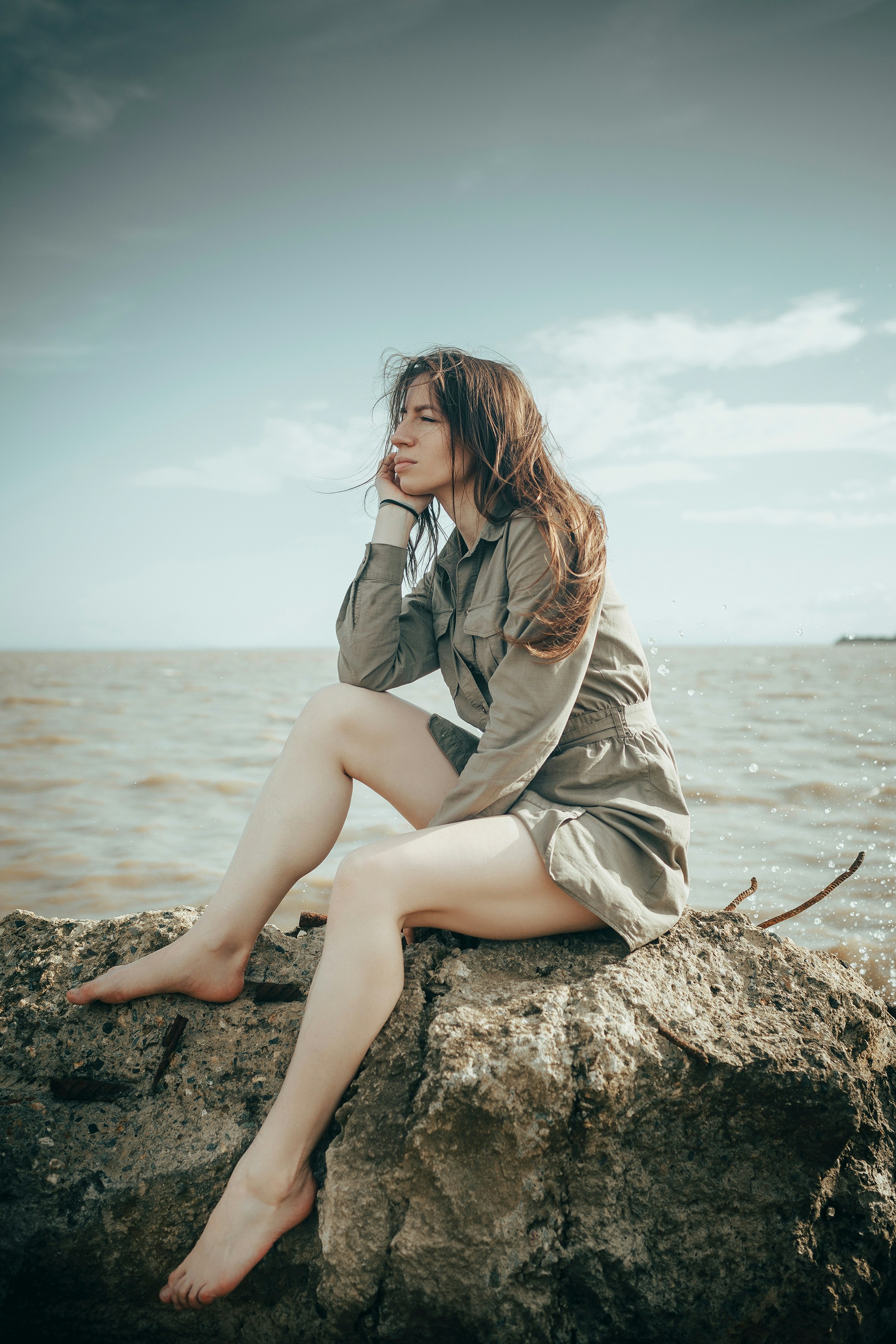 Seaside Quiet: A contemplative moment on weathered rocks