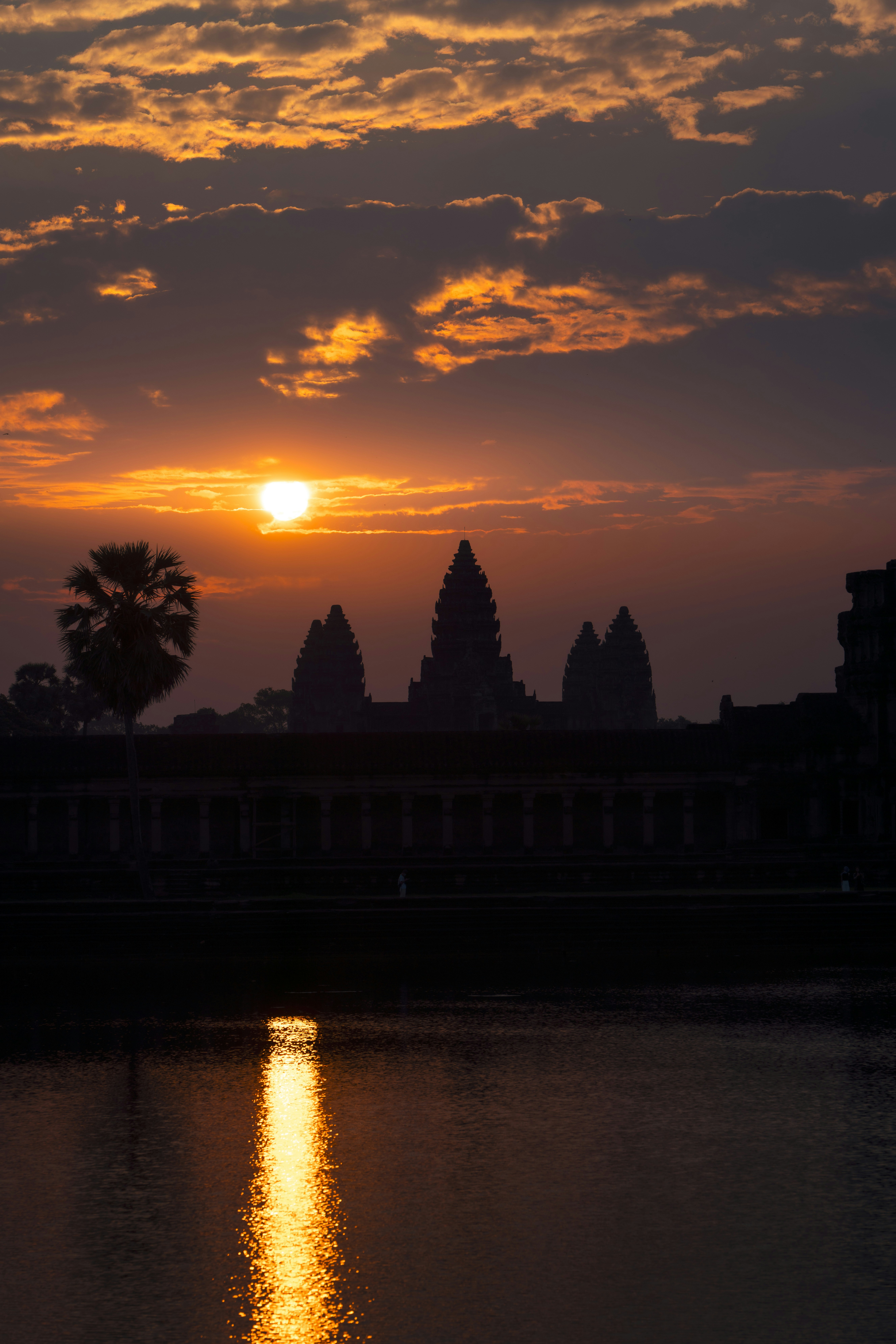 Silhouette of Angkor Wat at Sunset: A Quiet Portrait of Stone Towers and Water