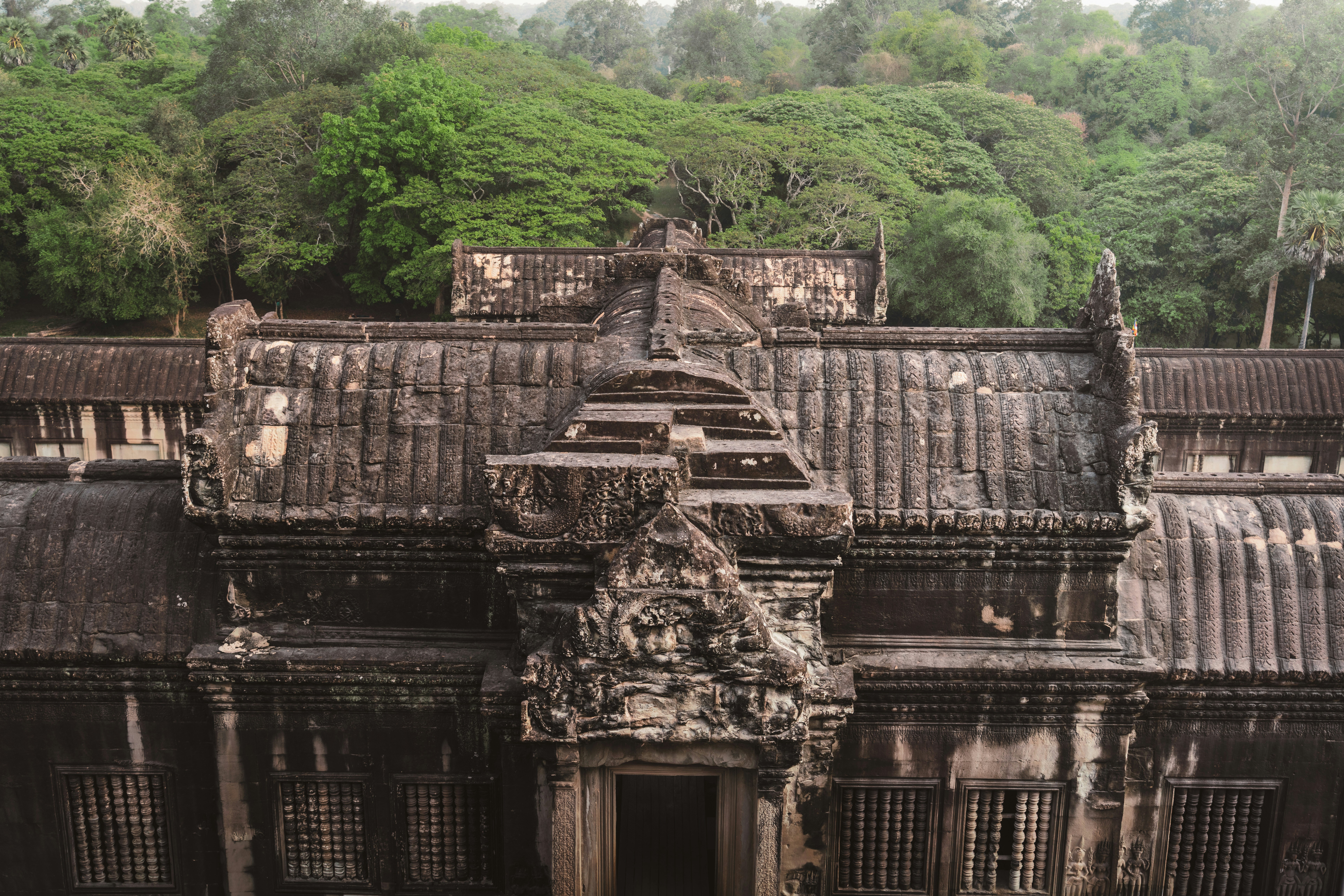 Overgrown Gateways: Aerial View of an Ancient Angkor-like Temple Courtyard