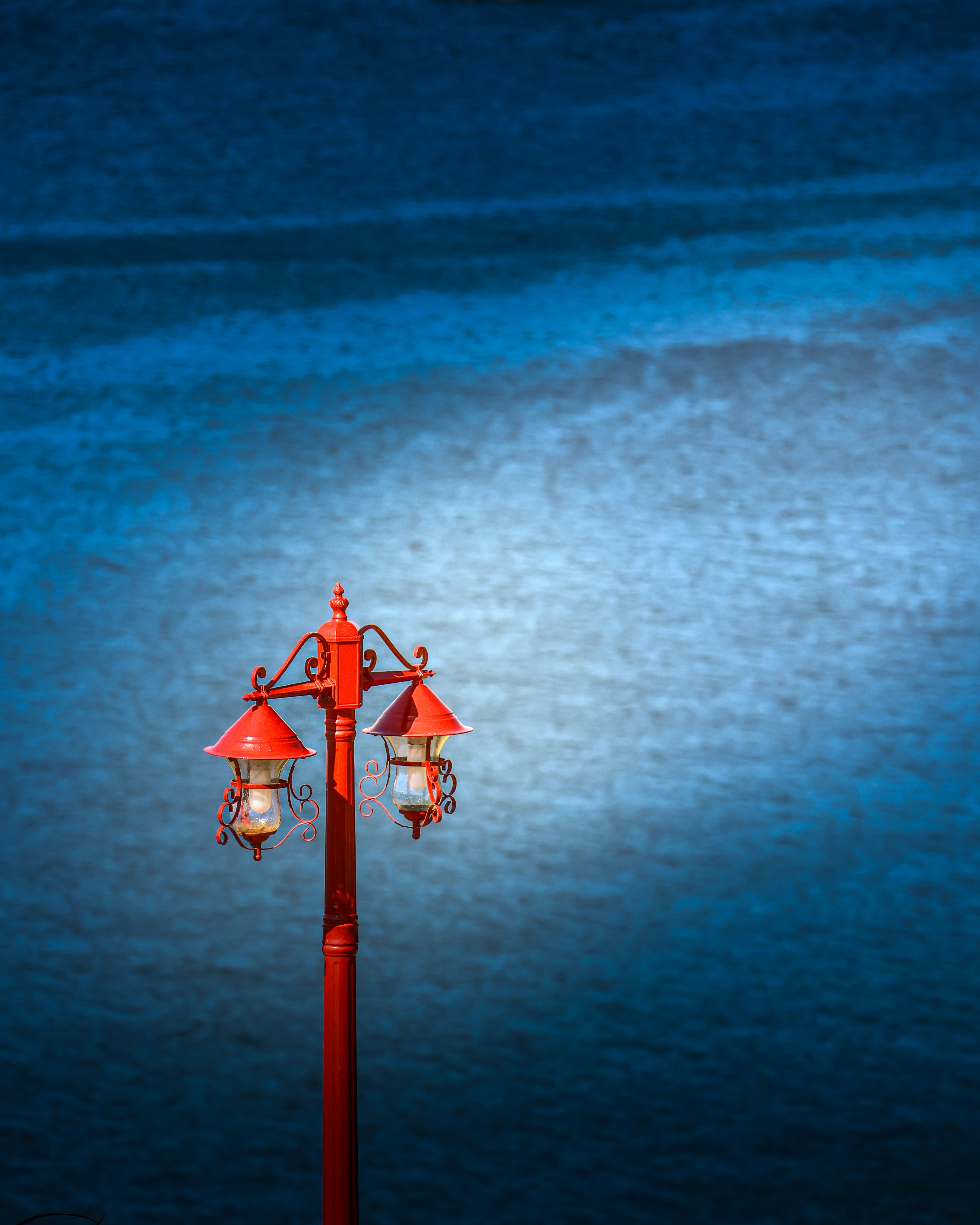 Red Lantern on a Quiet Blue Canvas