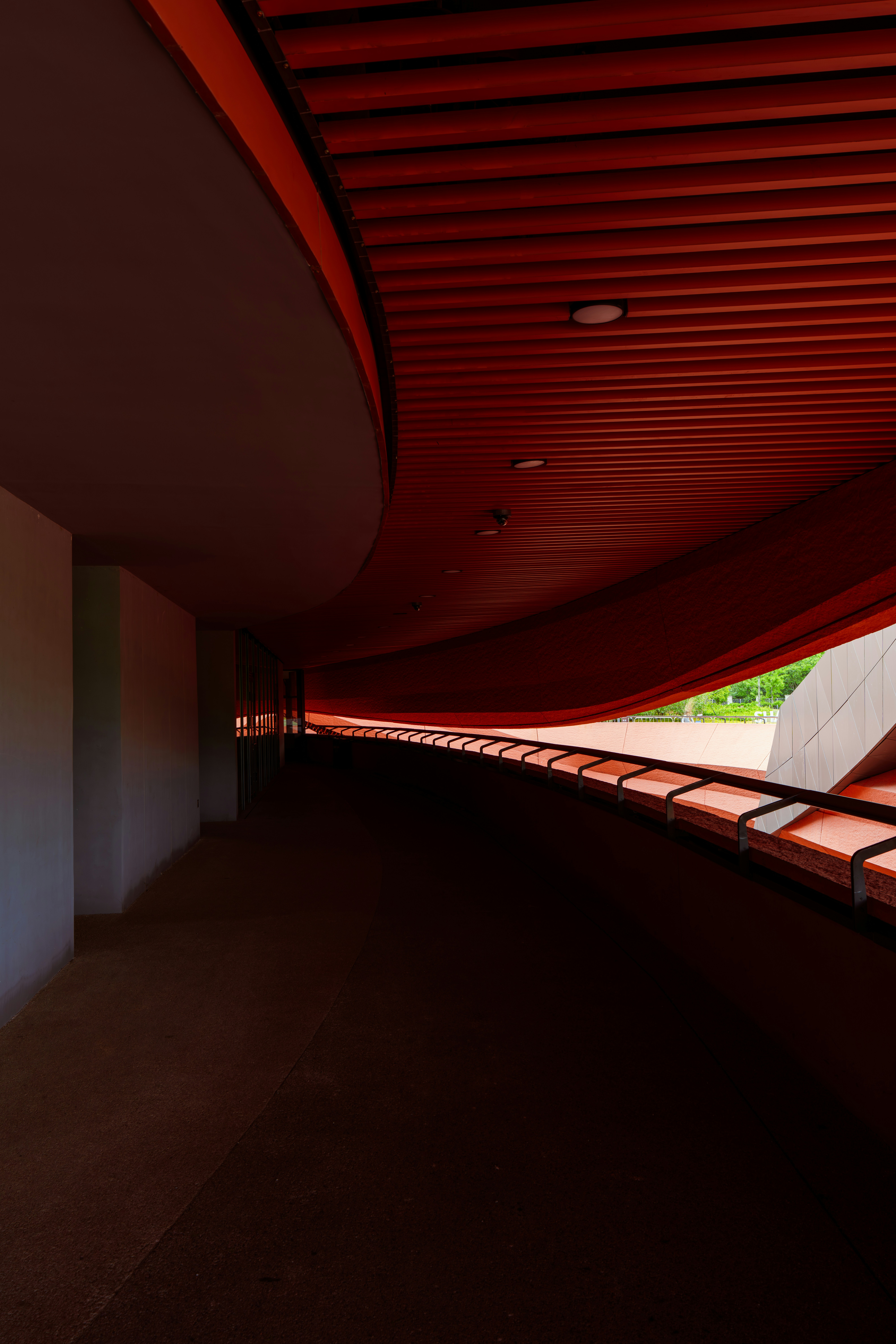 Red Corridor: A Quiet Archway Framed by Echoing Lines
