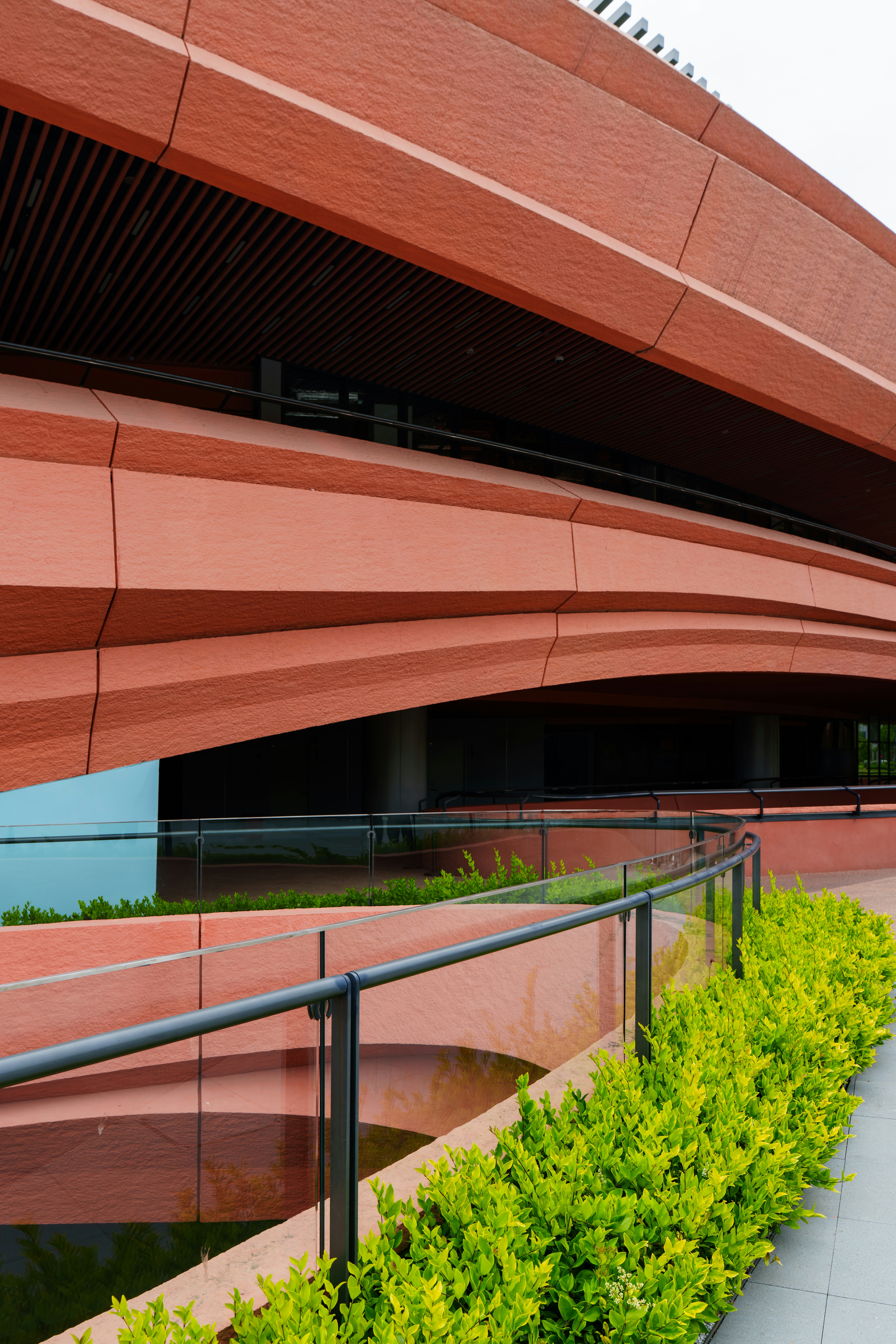 Curved Terracotta Waves of a Modern Atrium
