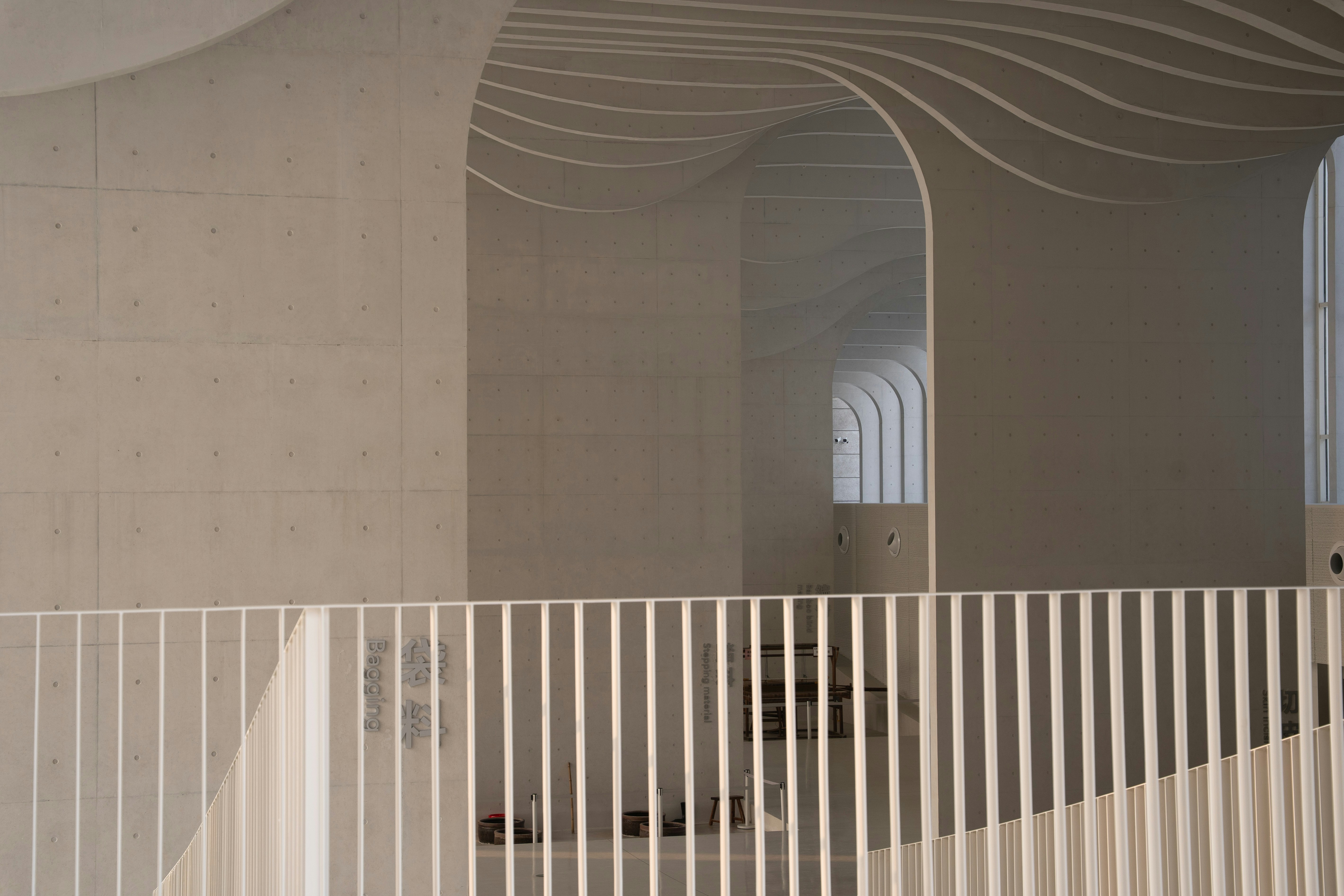 Architectural Corridor: Light through Arched Portal Framing the Minimal Atrium
