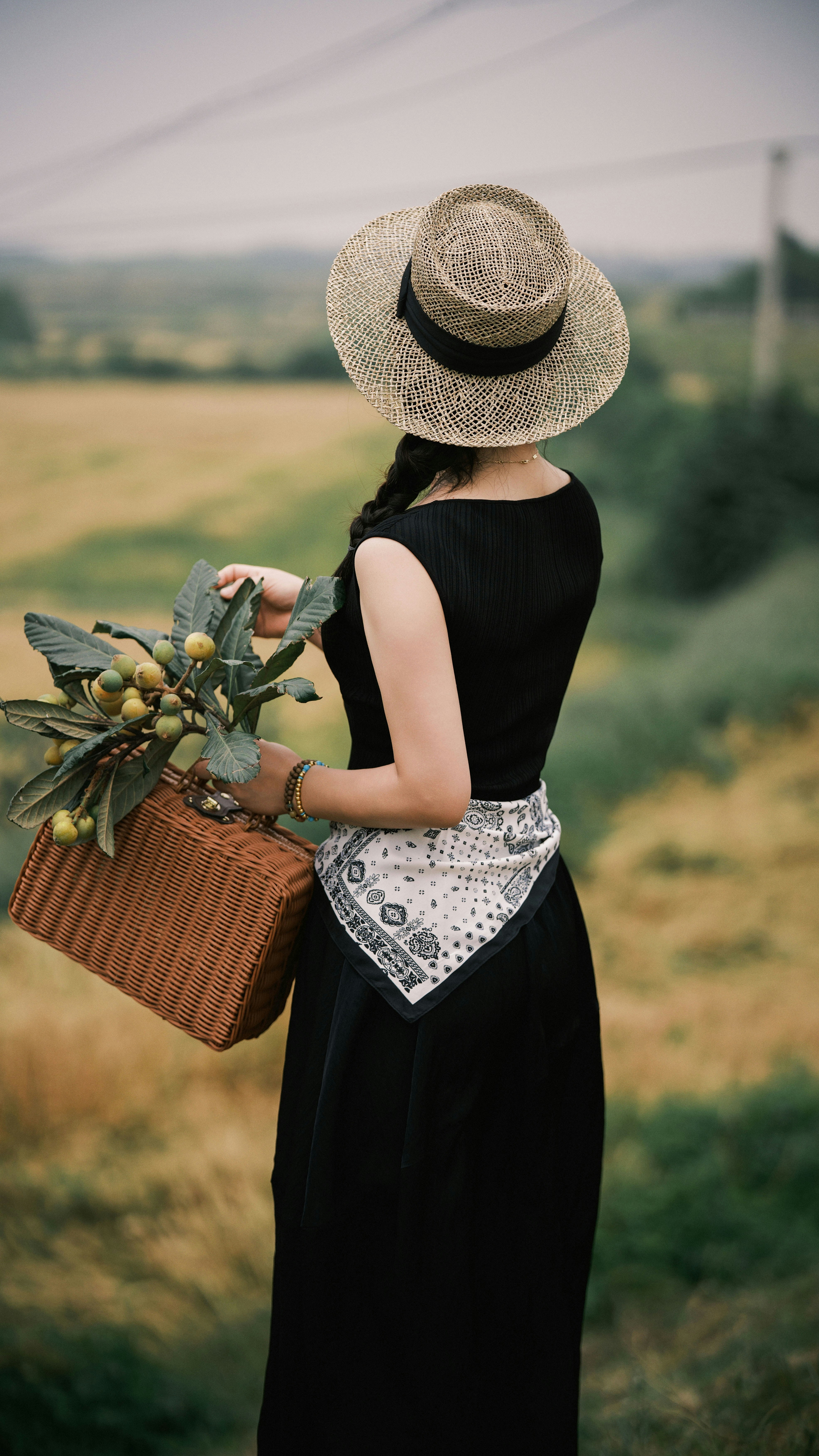 Sunlit Farm Muse: A Straw Hat and Basket in a Quiet Field