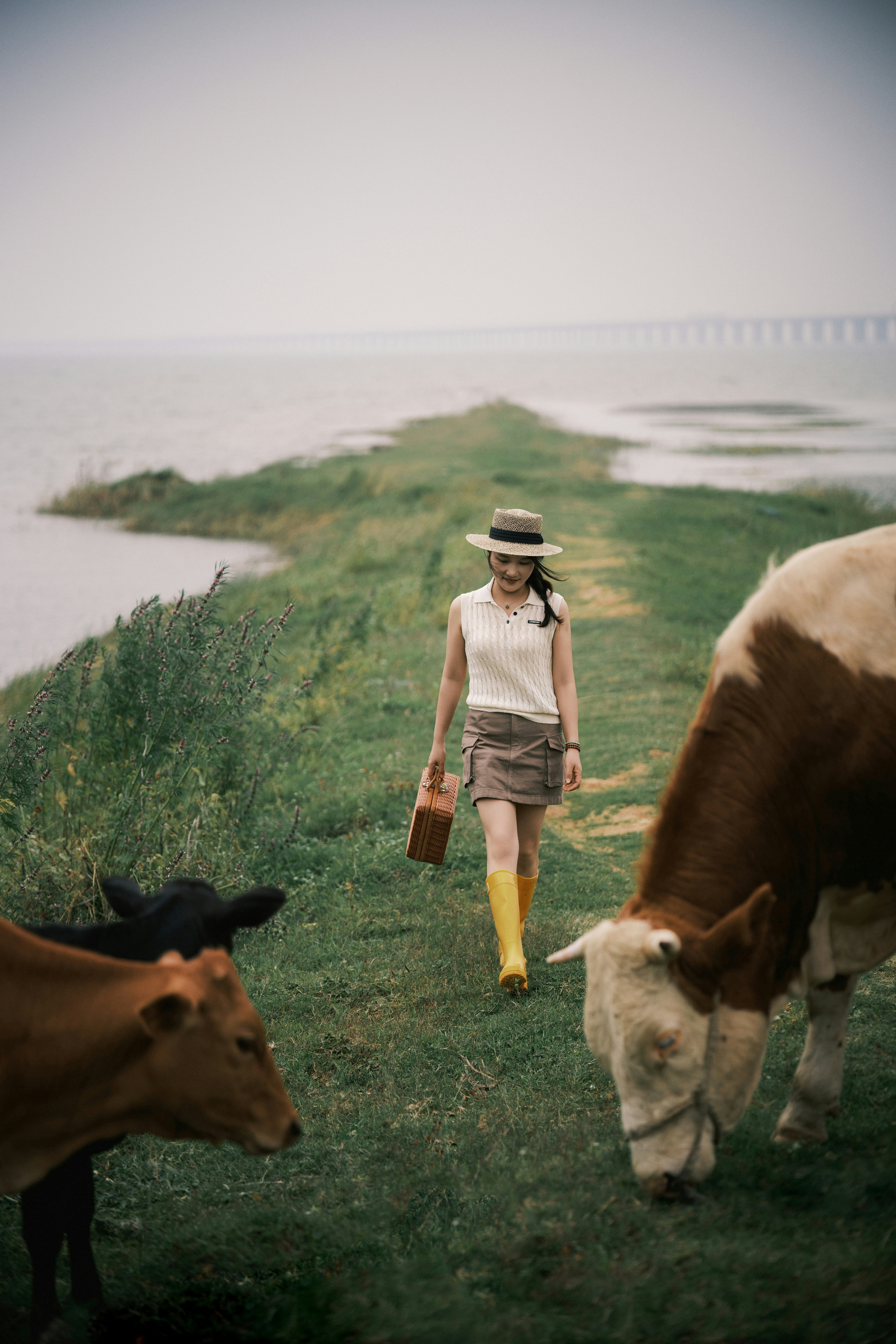 Heron Path: A Girl in Yellow Boots Among Grazing Horses