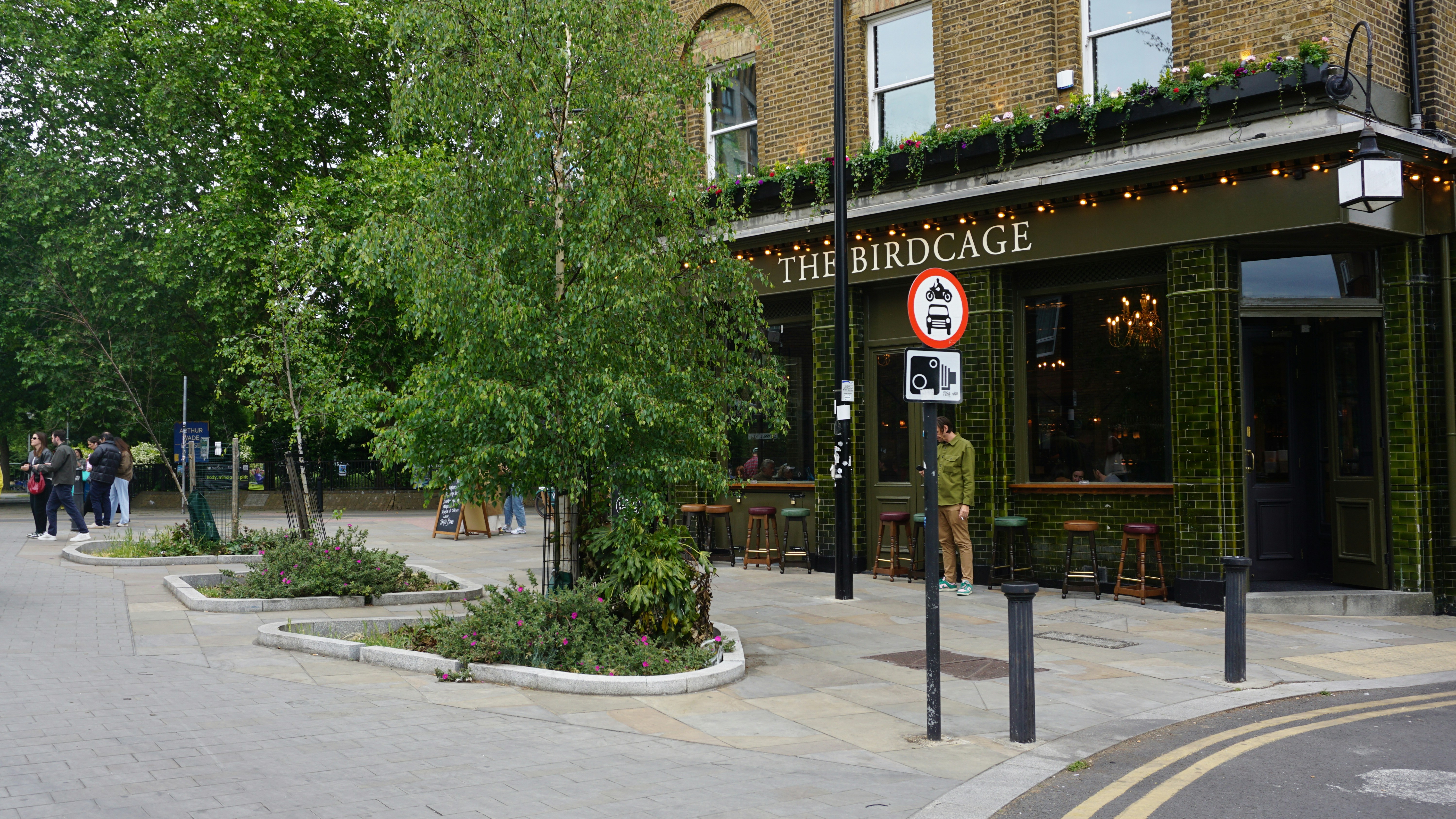 The Birdcage Café Corner Under a Green Canopy