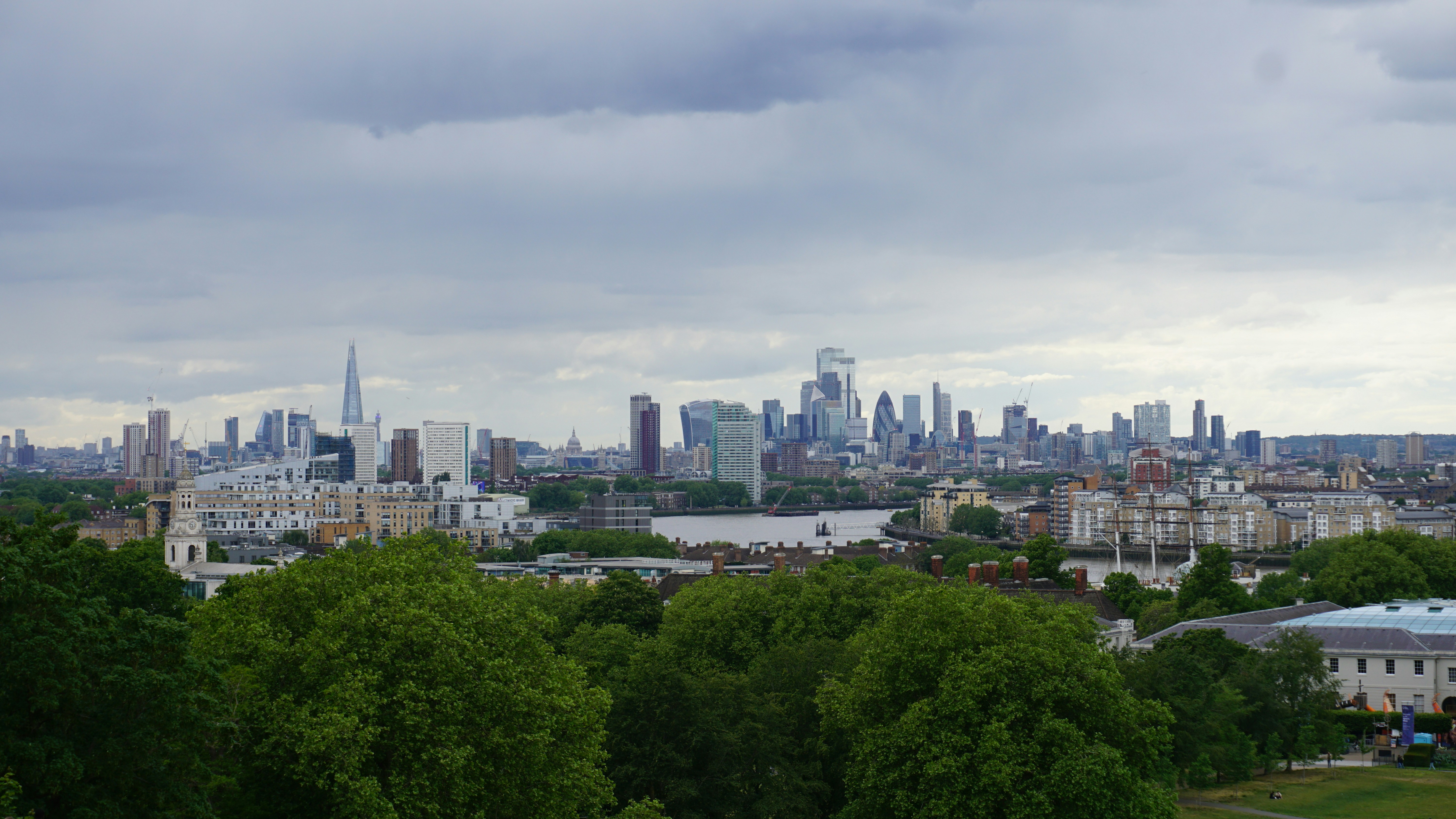 Urban Twilight: City Skyline Over Verdant Foreground