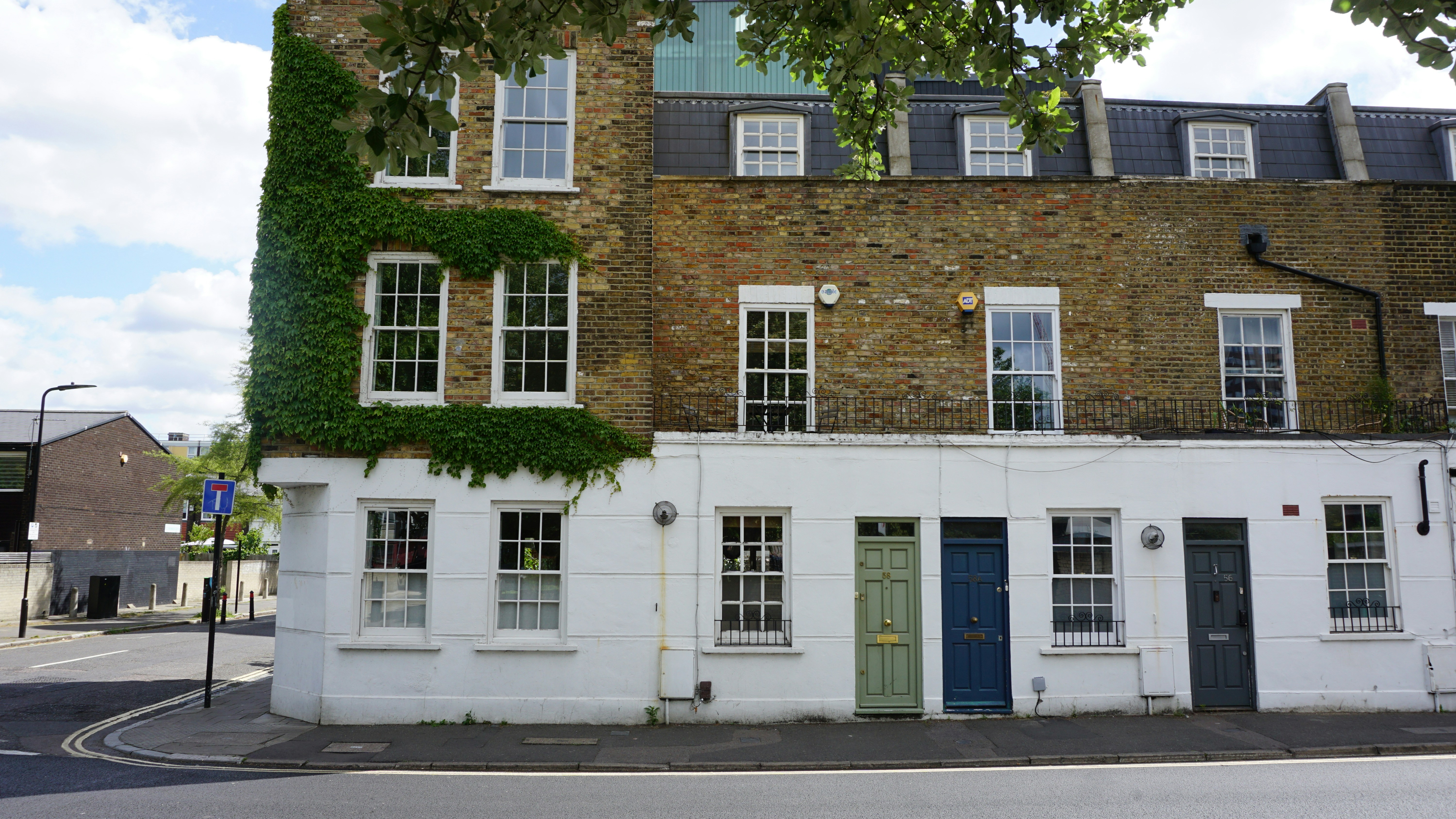 Row of ivy-clad townhouses on a quiet street