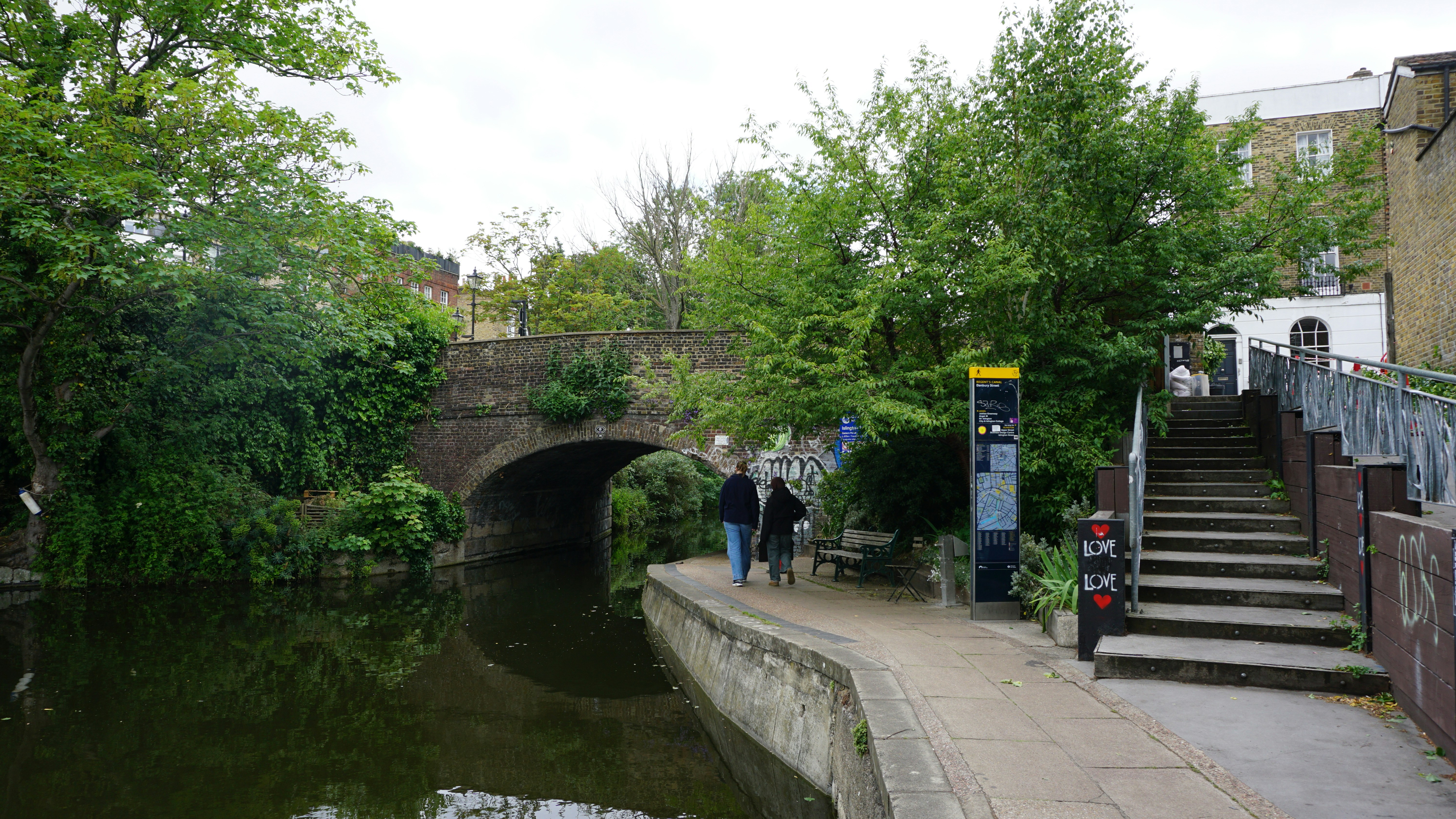 Couple by the Stone Bridge: Quiet Riverside Stroll