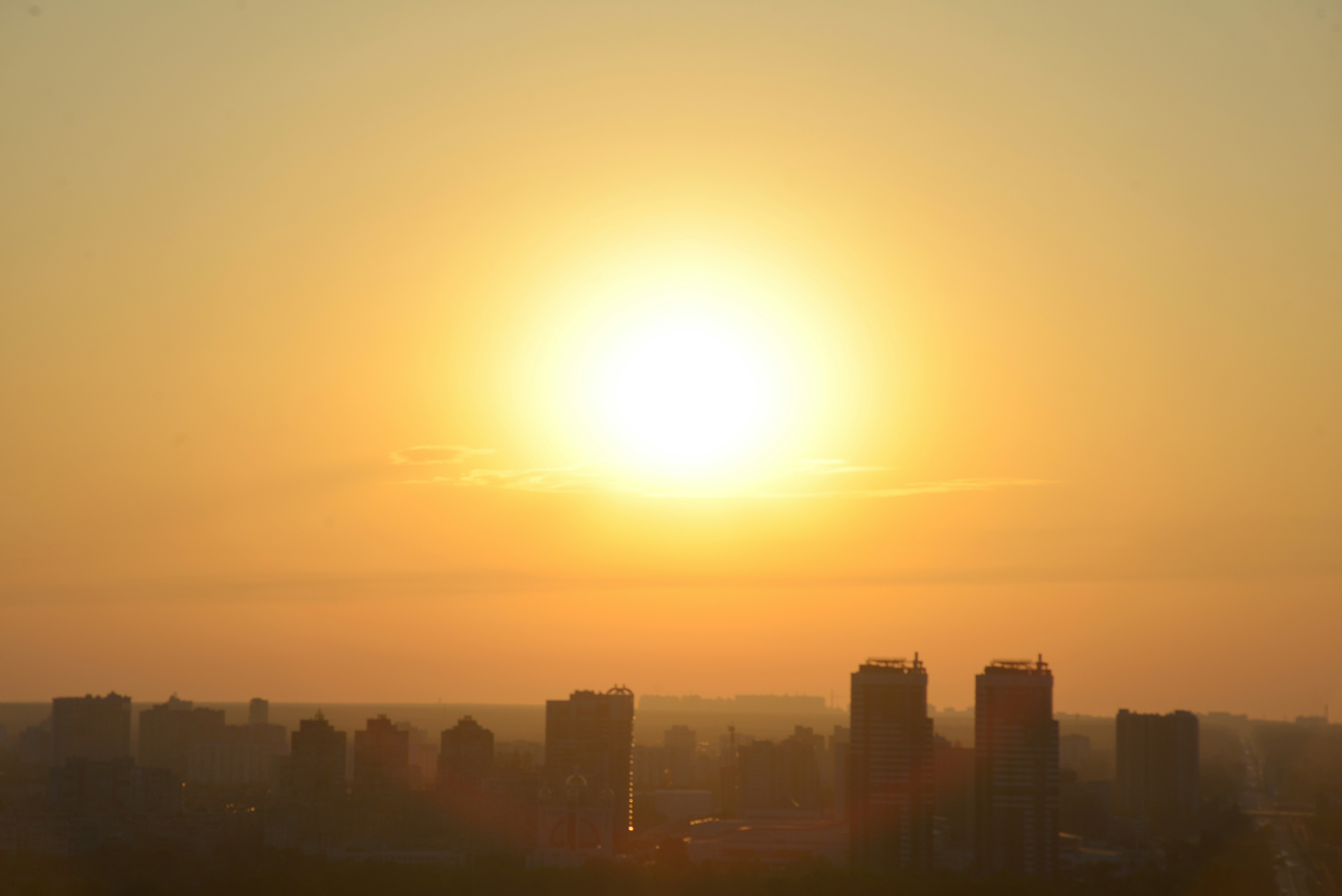 Sunlit Horizon Over Quiet City Silhouette