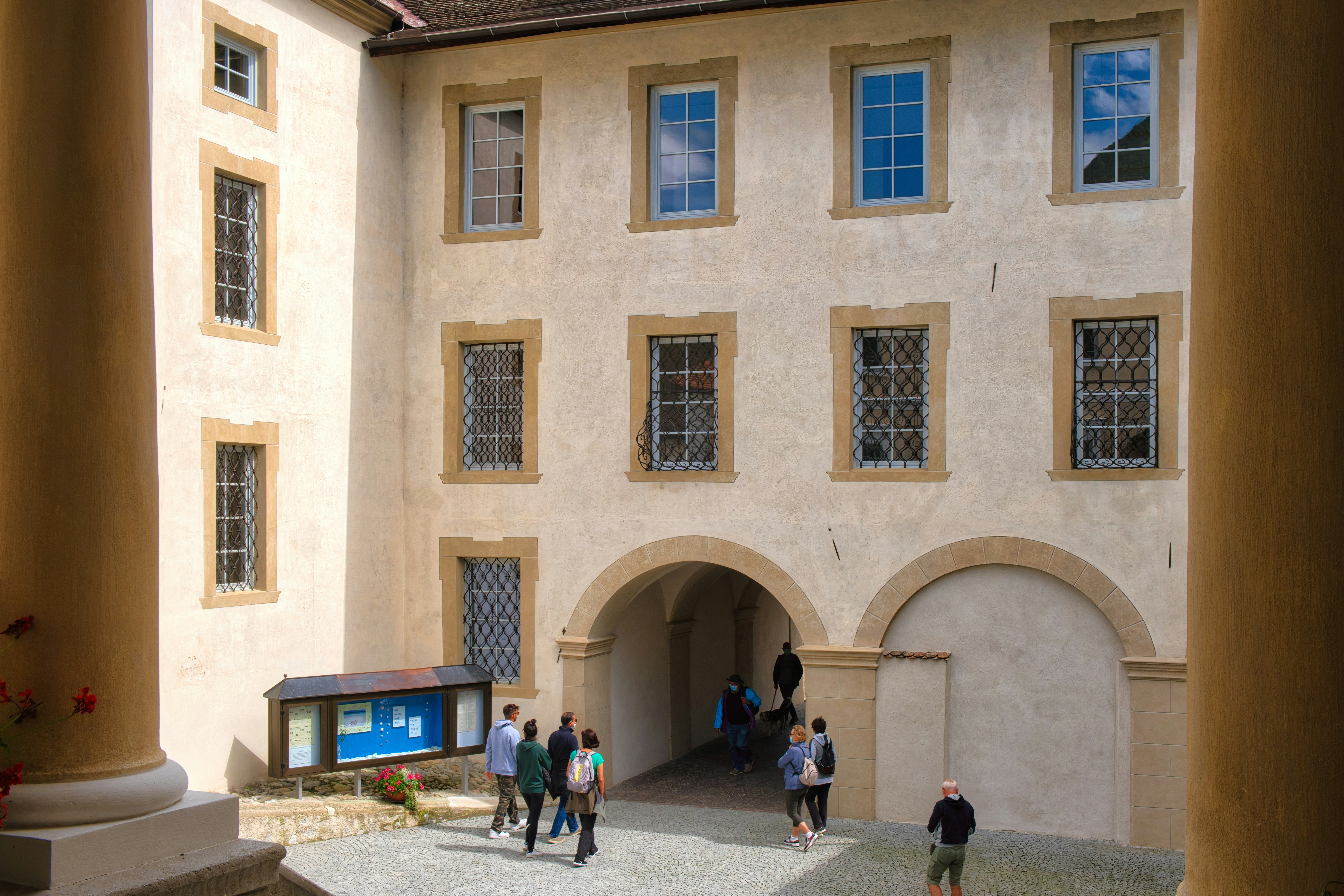 Courtyard Entry: Light, People, and Arched Gateways