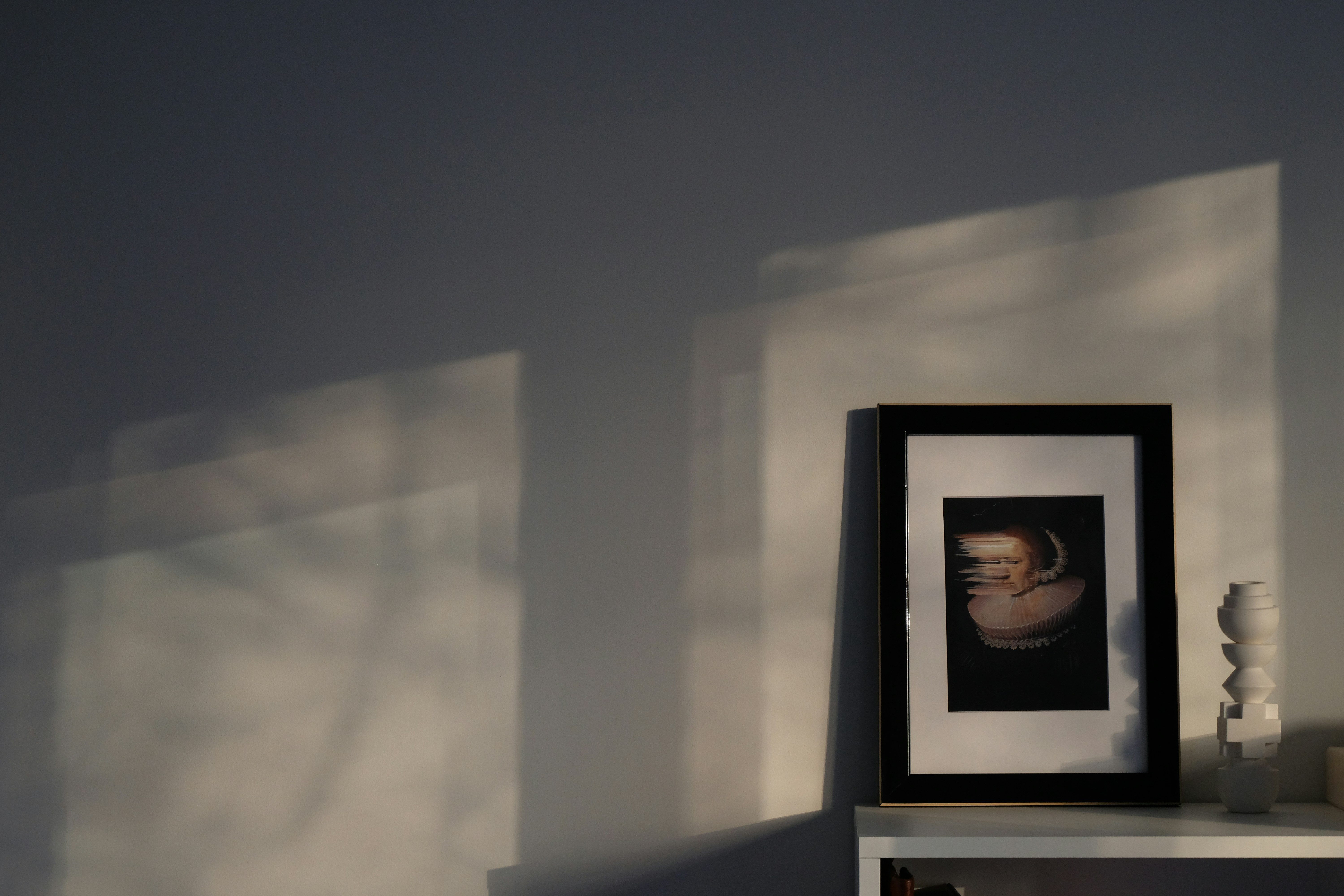Shadowed Frames: Framed Artwork and Echoes of Light