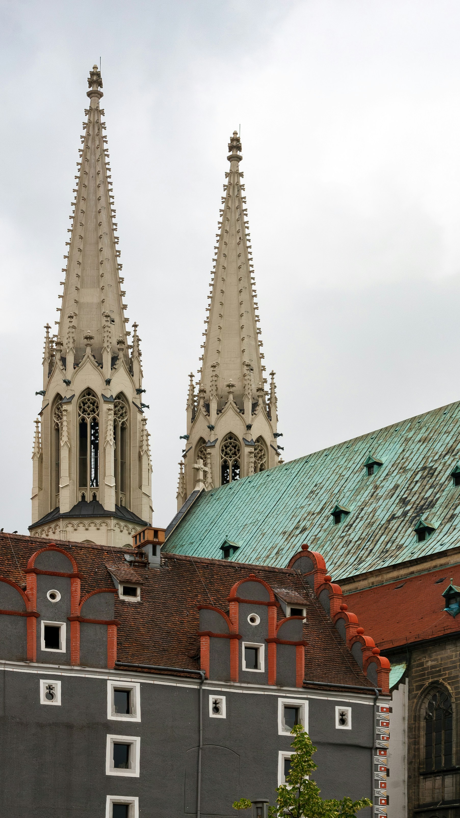 Gothic Spires Above a Colorful Urban Roofline