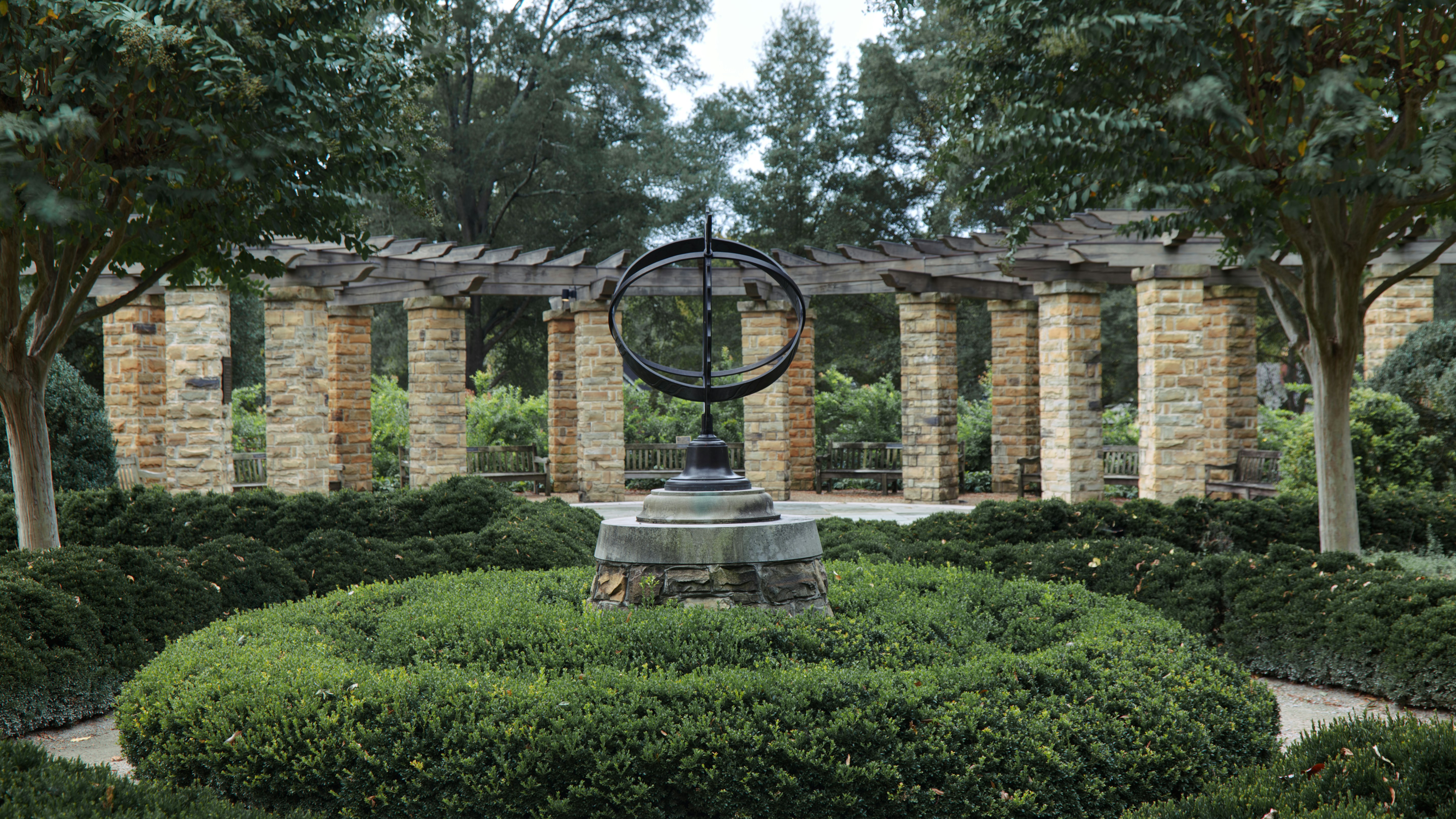 Circular Sphere Fountain at a Classic Stone Arcade Garden