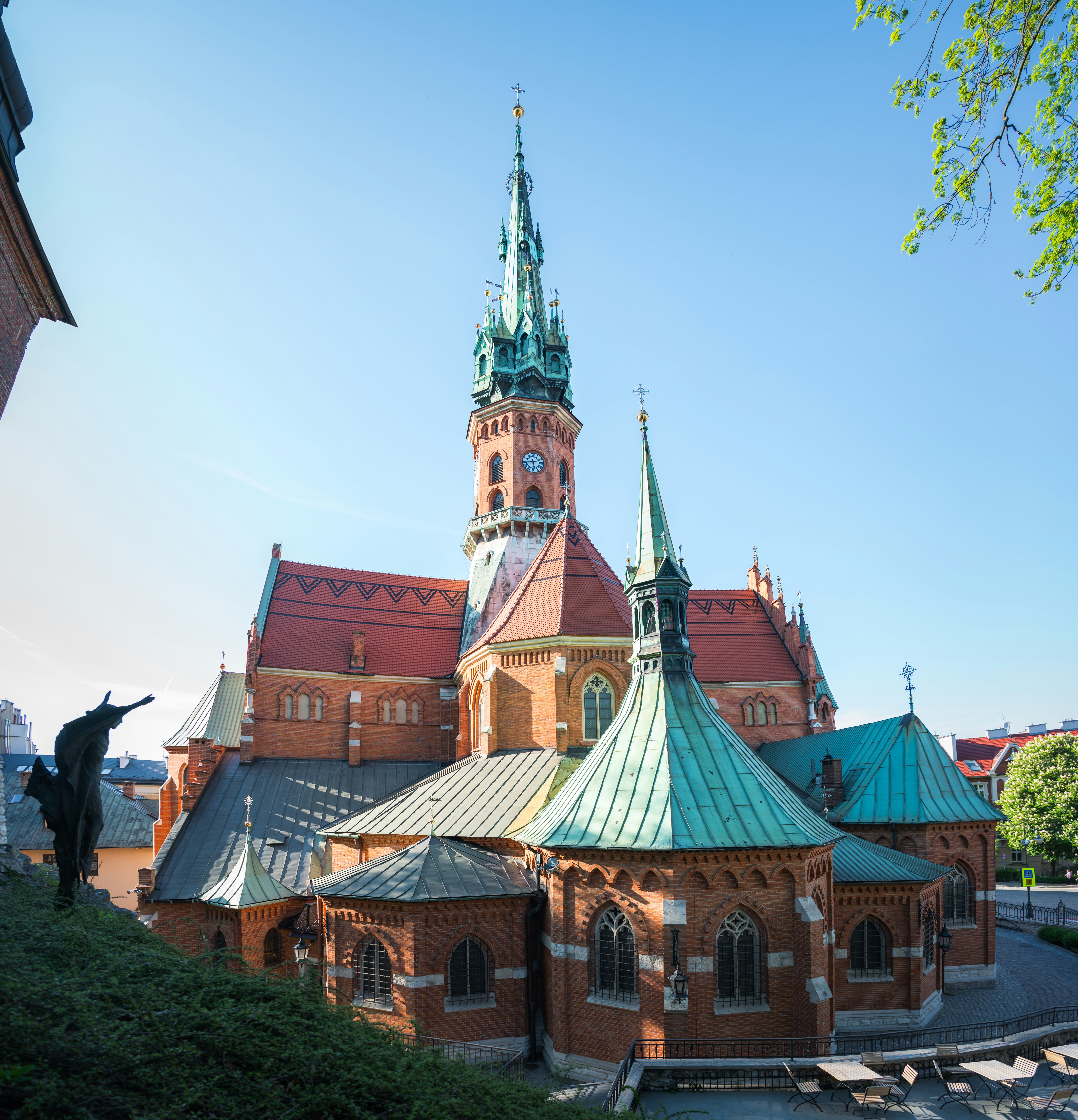 Gothic Spire and Brick Cathedral: A Sunlit City Landmark