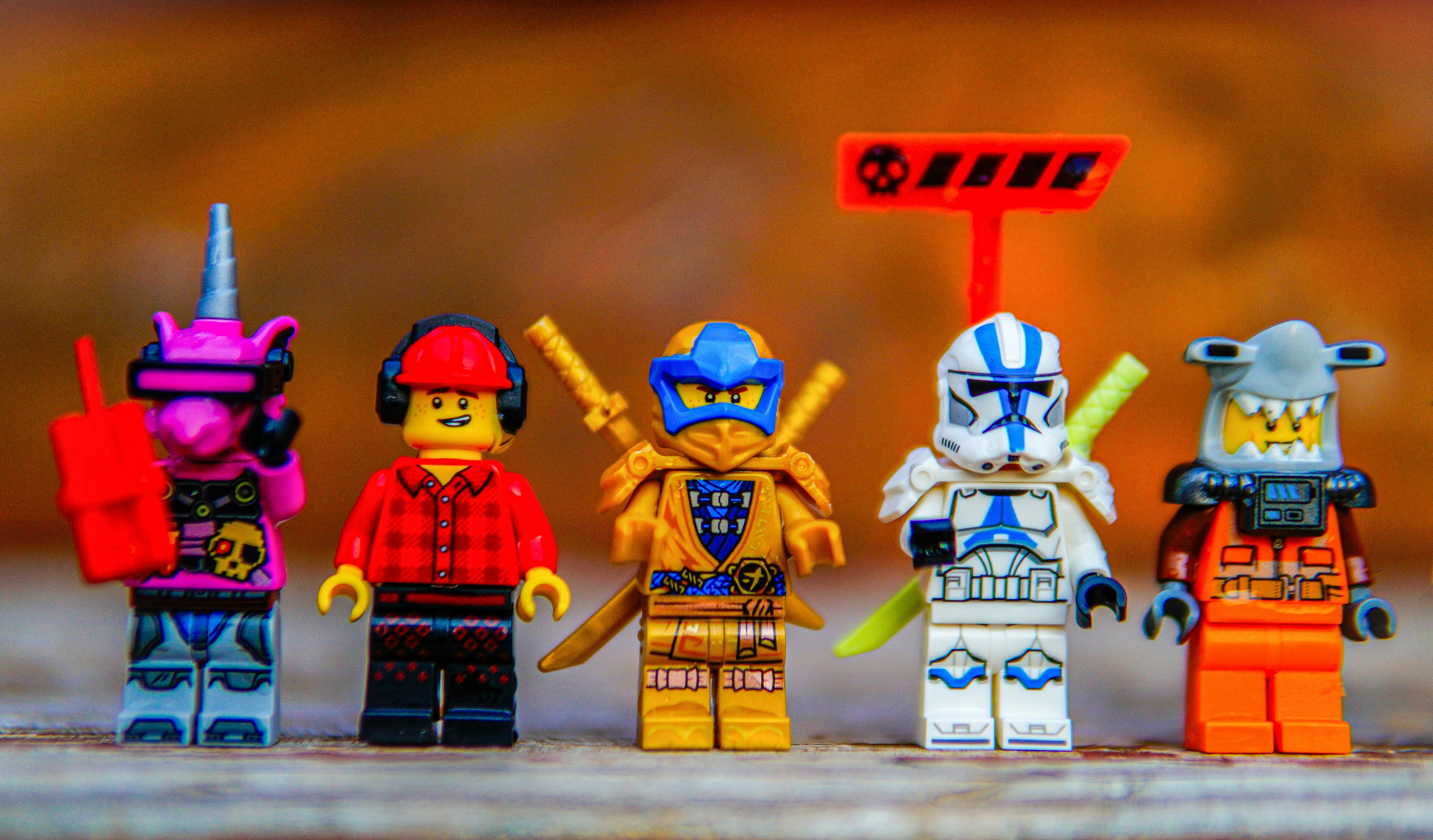 Five colorful Lego Warriors Stand Guard on a Wooden Surface