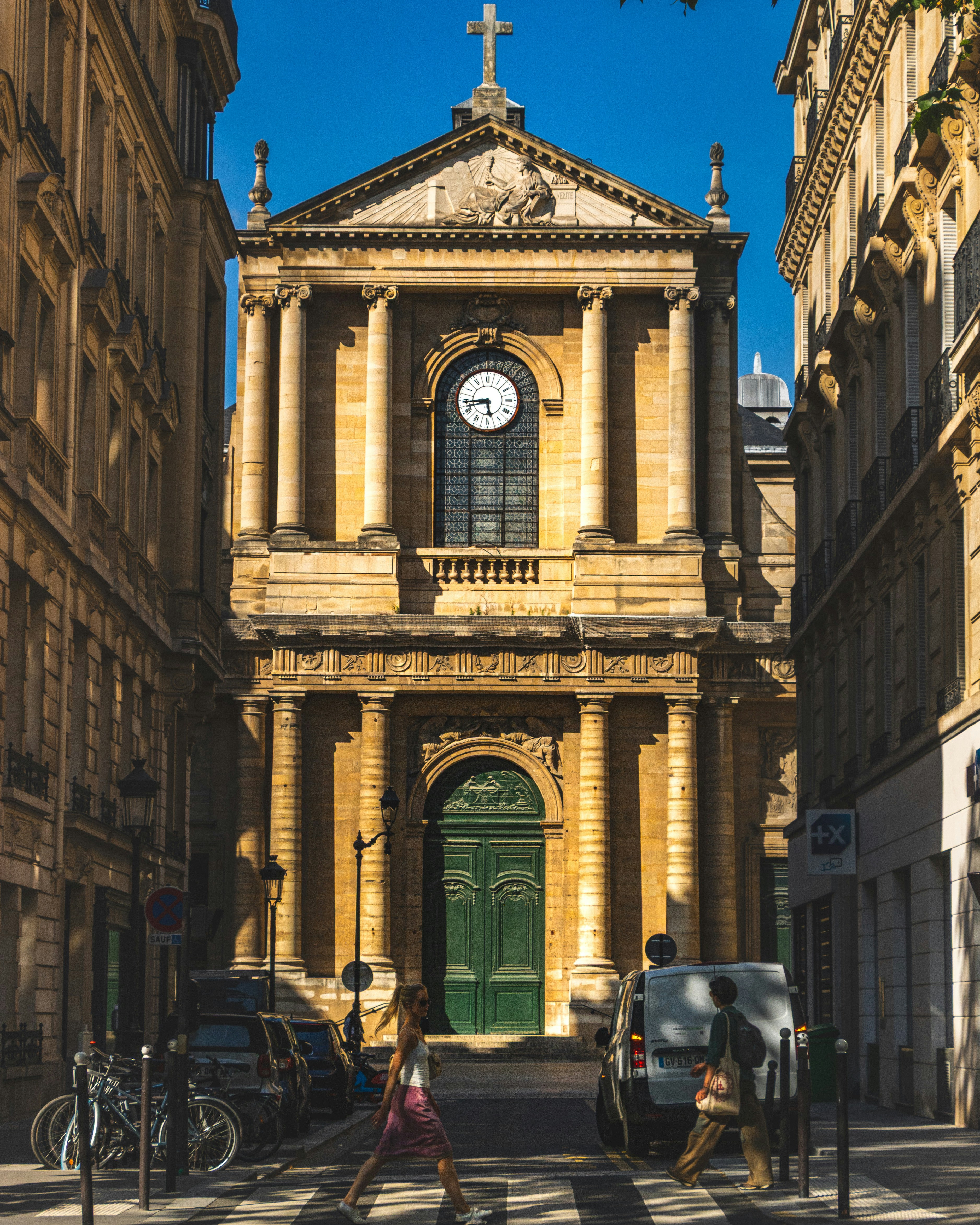 Sunlit Baroque Facade Framed by Narrow Parisian Street